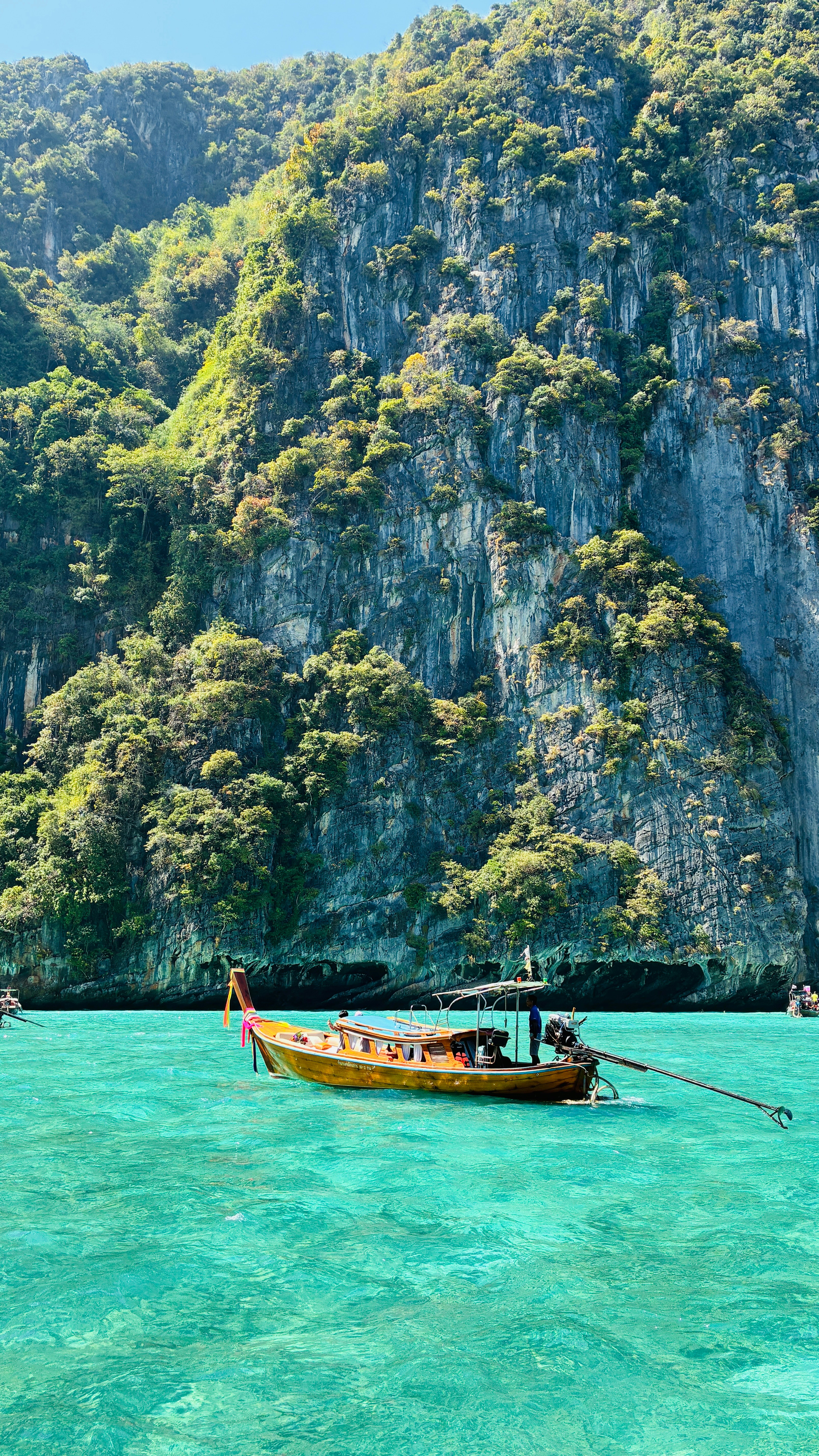 Emerald Boat at the Foot of a Cliff
