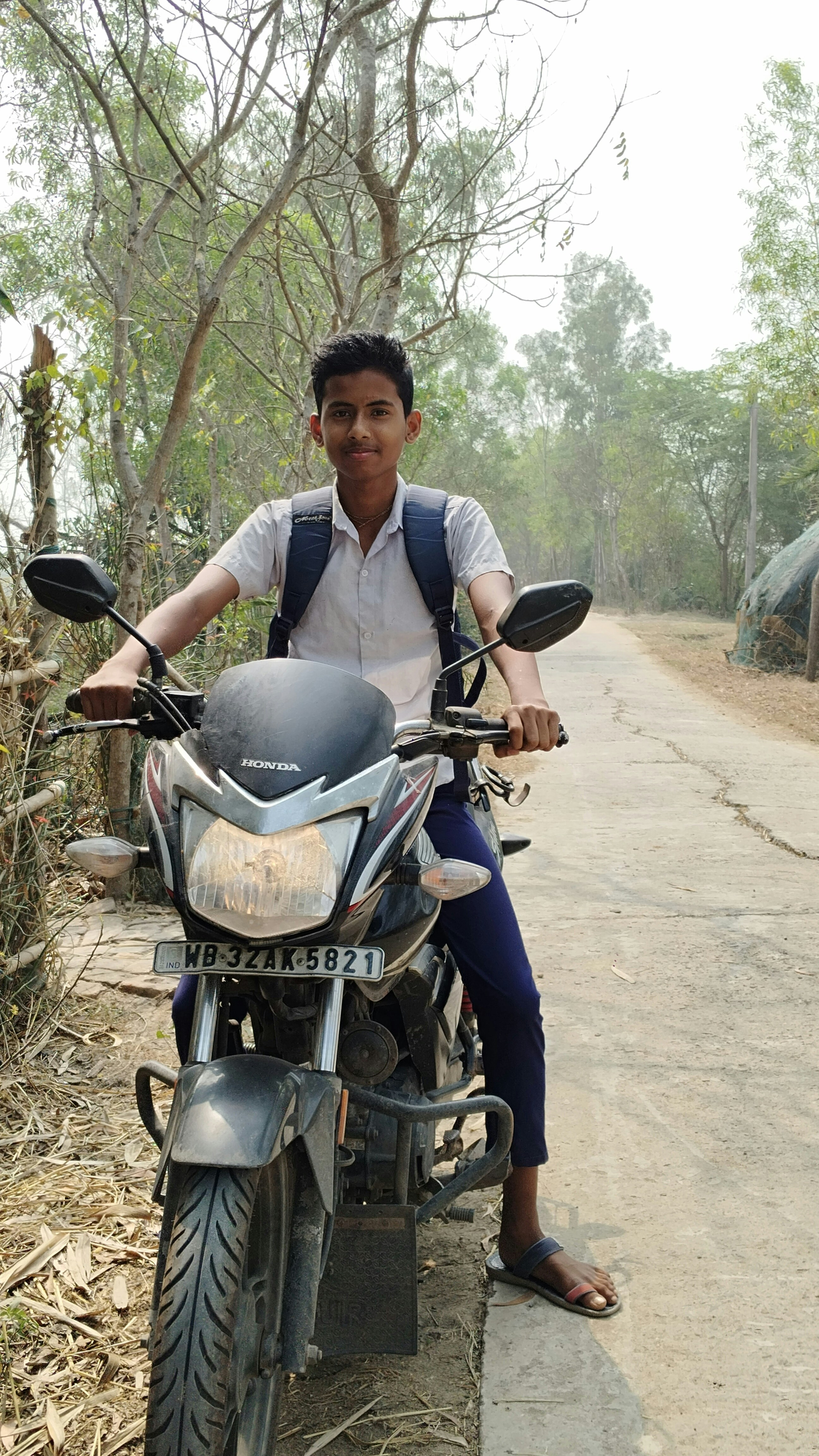 Front-Column Rider: A Youth on a Honda in a Quiet Roadway