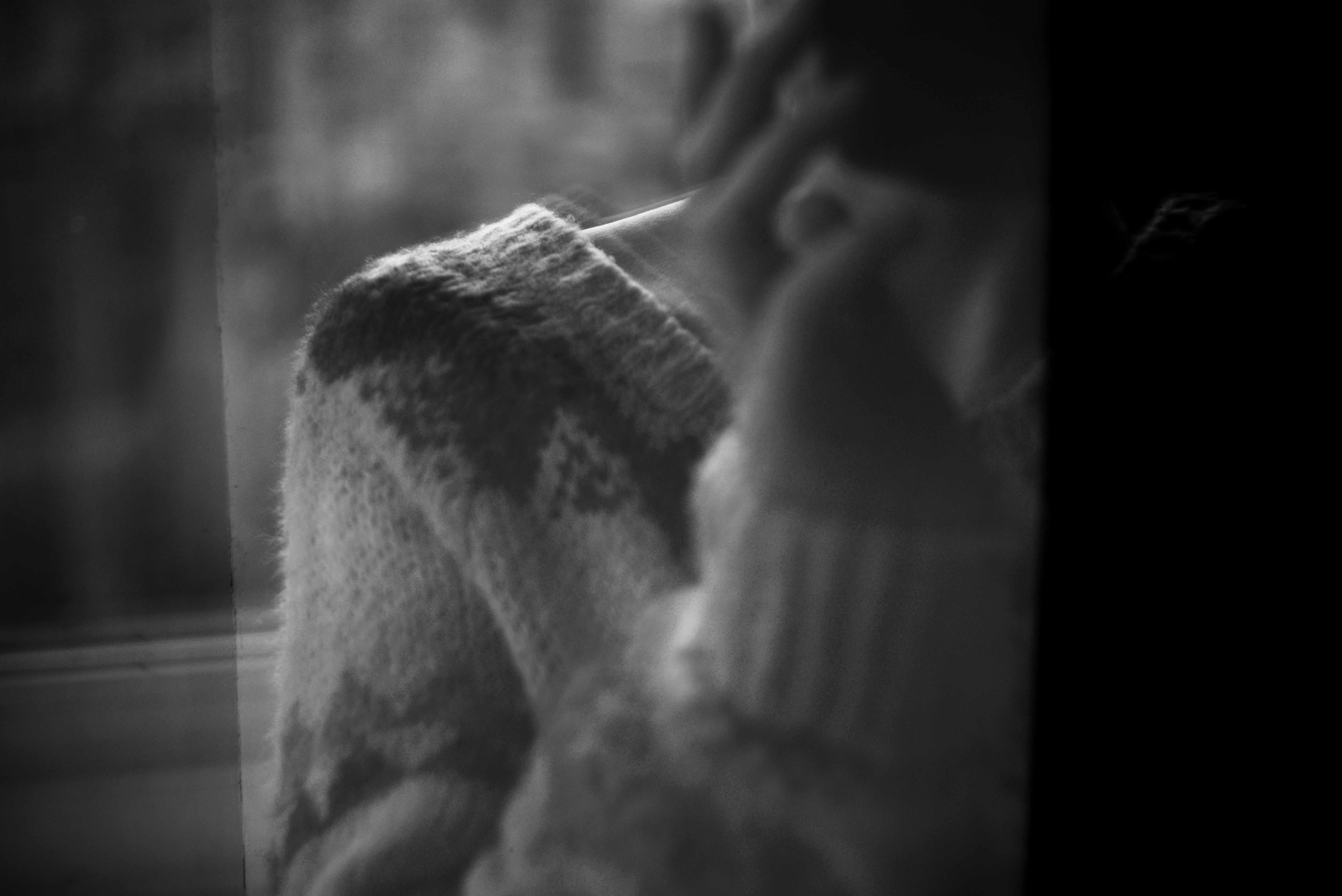 Soft Mystery: A Glimpse Through Fabric and Light