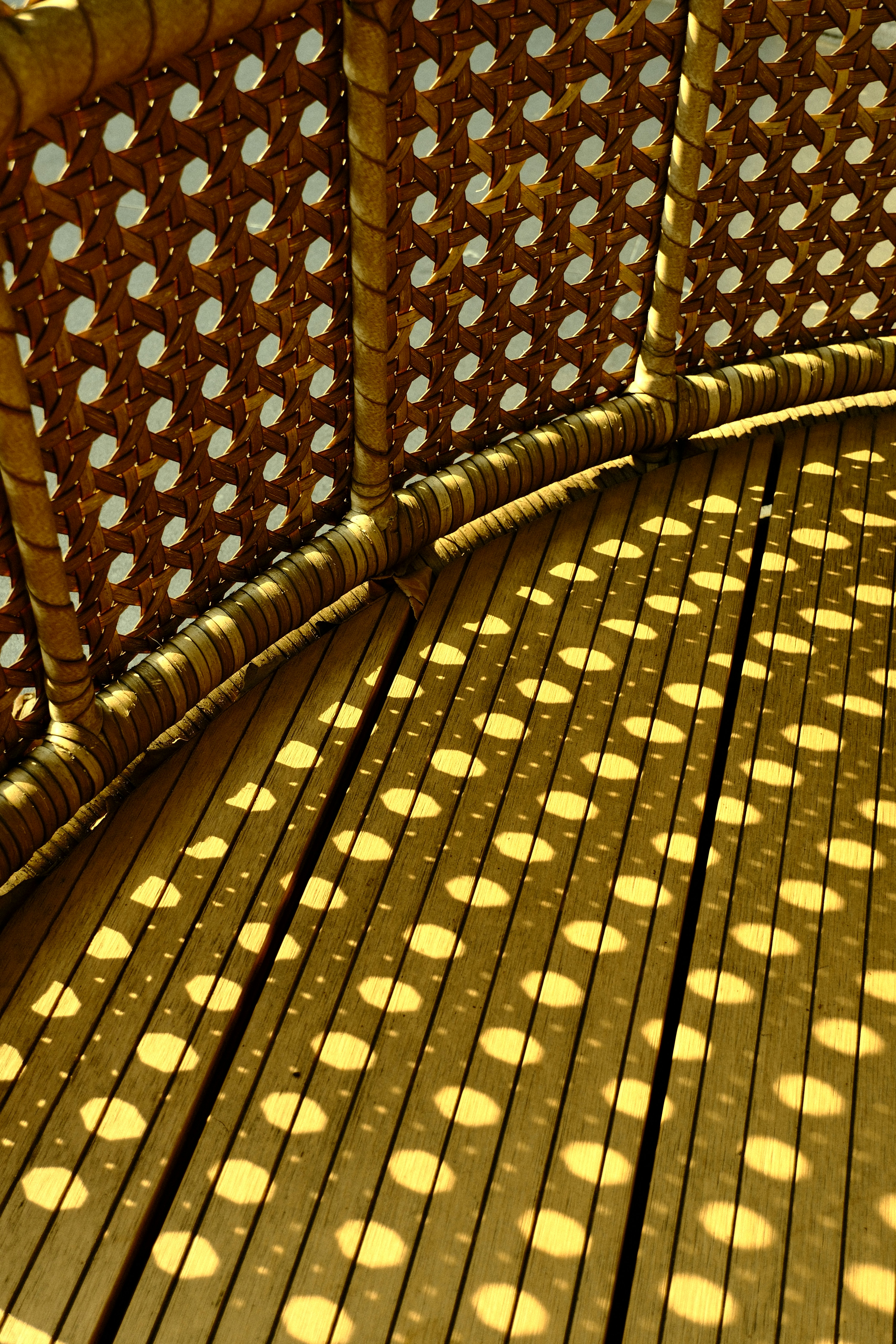 Sunlit Weave: Dappled Shadow Rhythms on a Woven Balcony