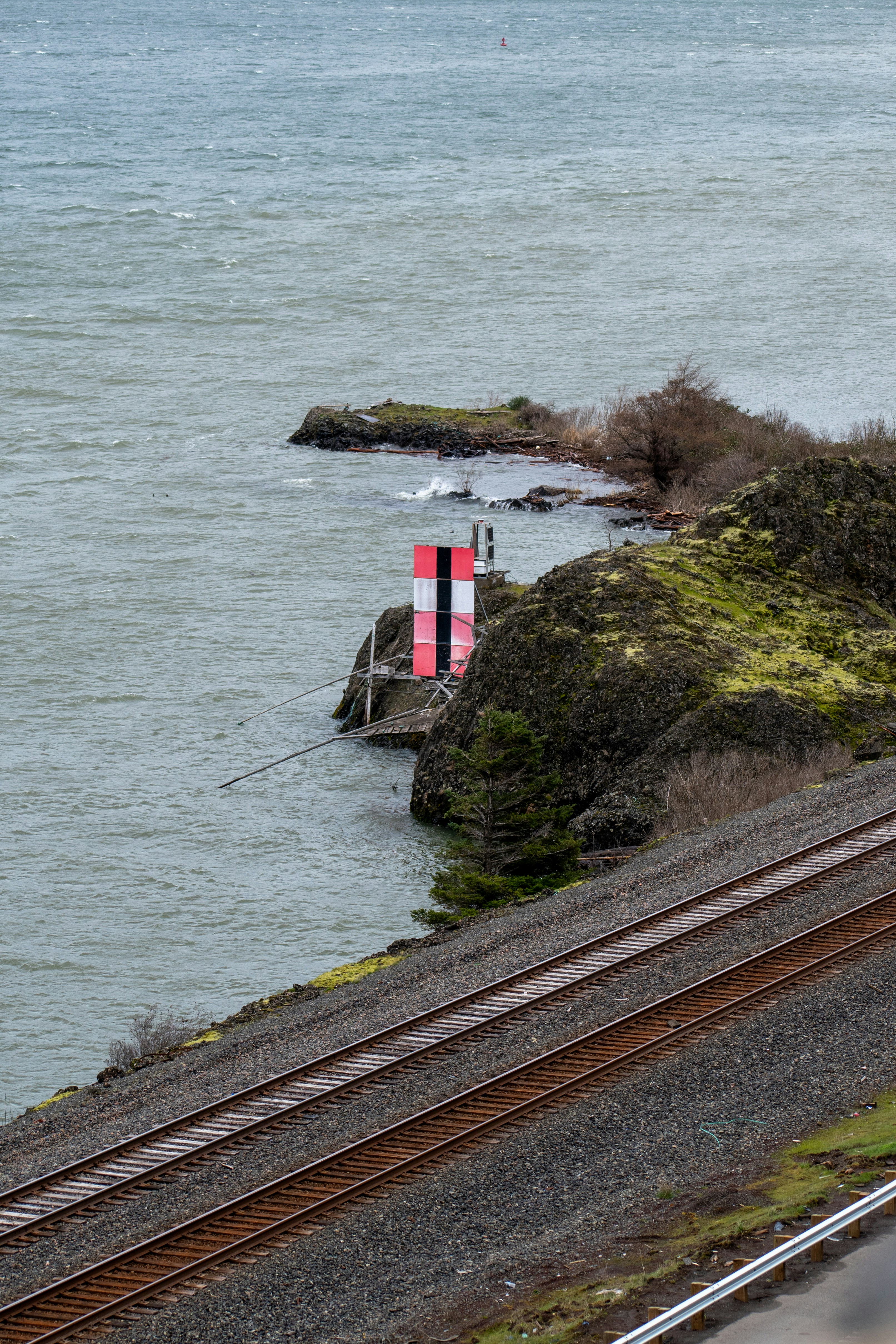Coastal Rail by the Sea: A Signal Post on Mossy Cliffs