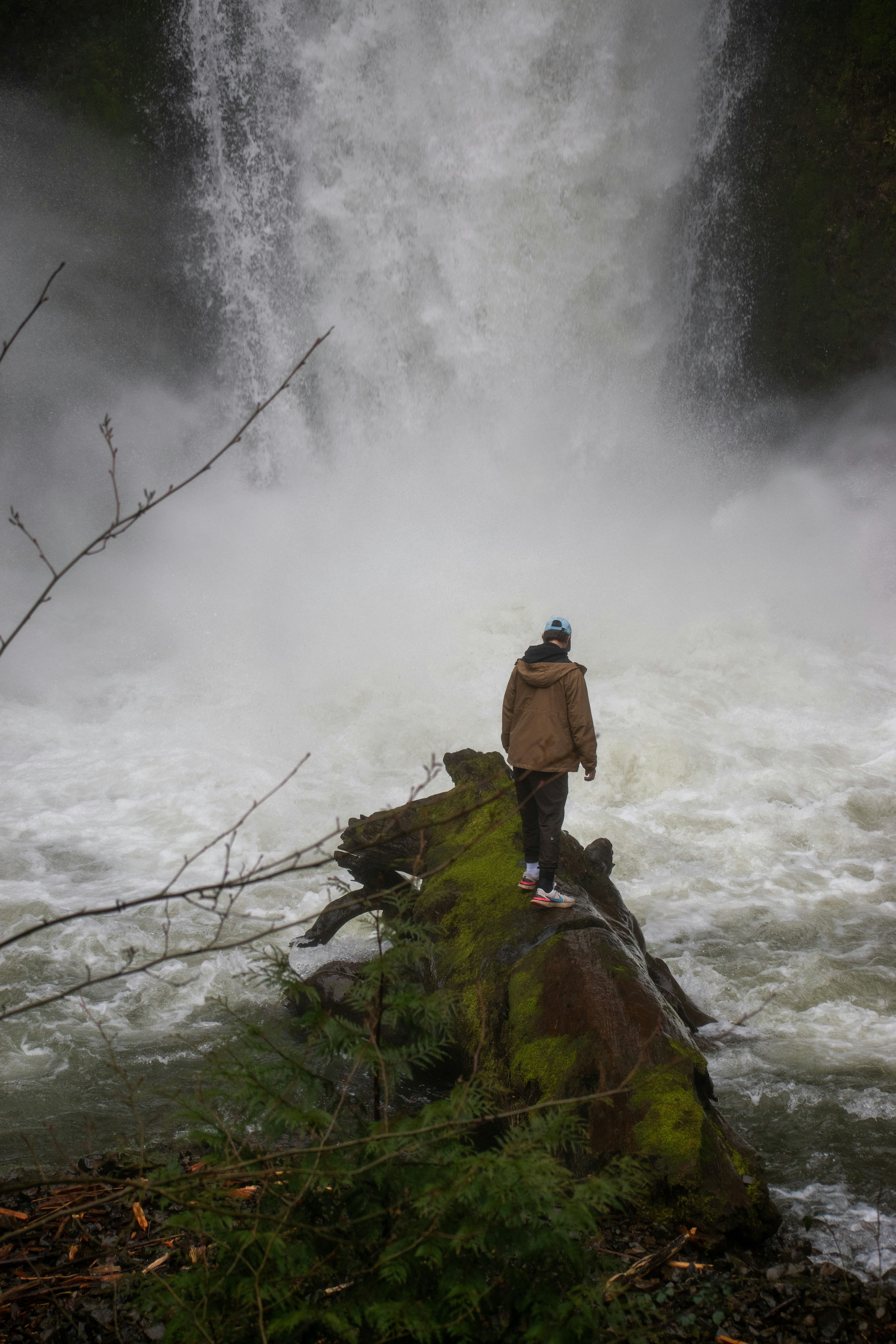 Standing on Mossy Rock Amid a Thunderous Cascade