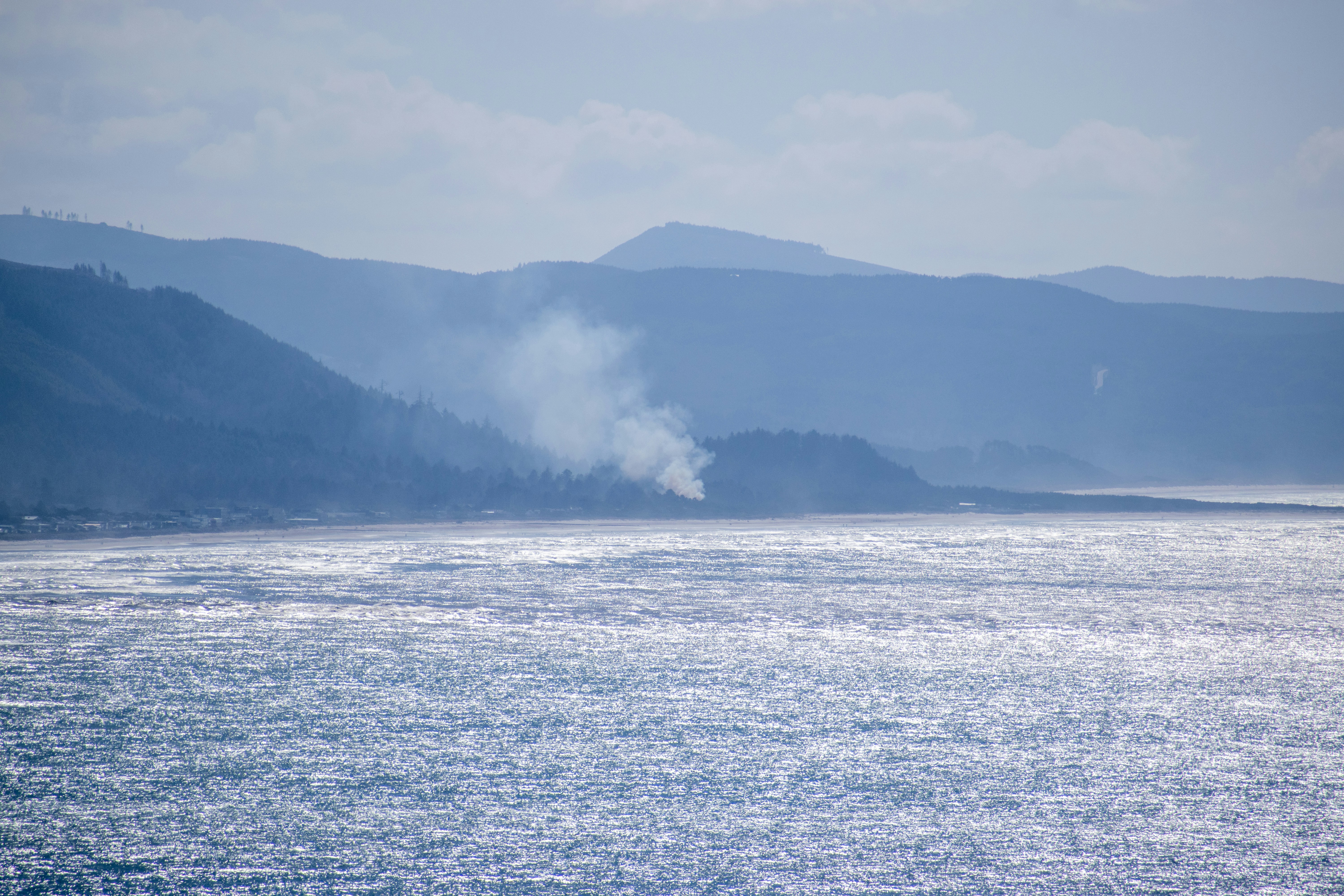 Mist over distant hills and glittering water