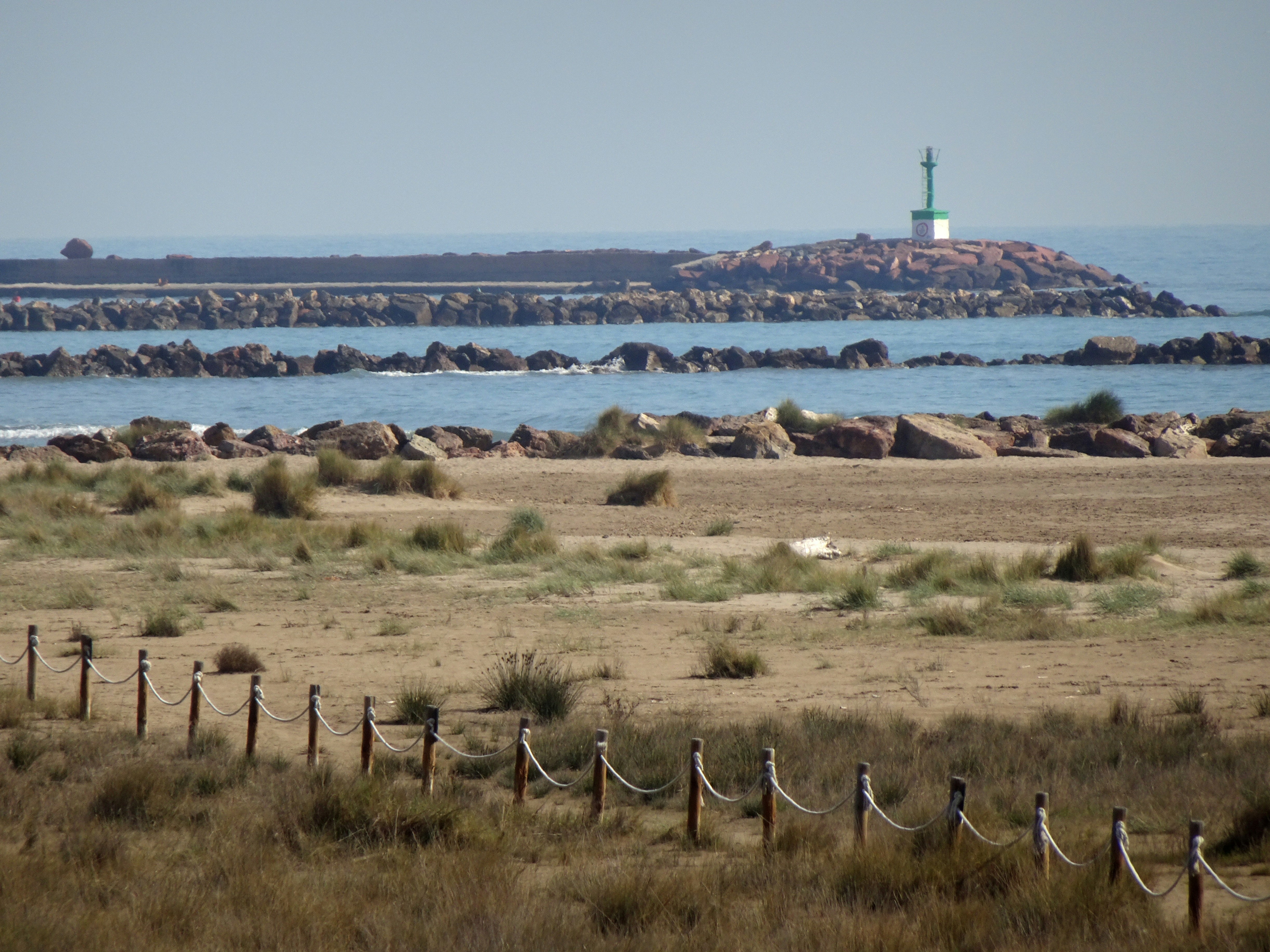 Coastal Promenade Toward a Lone Lighthouse
