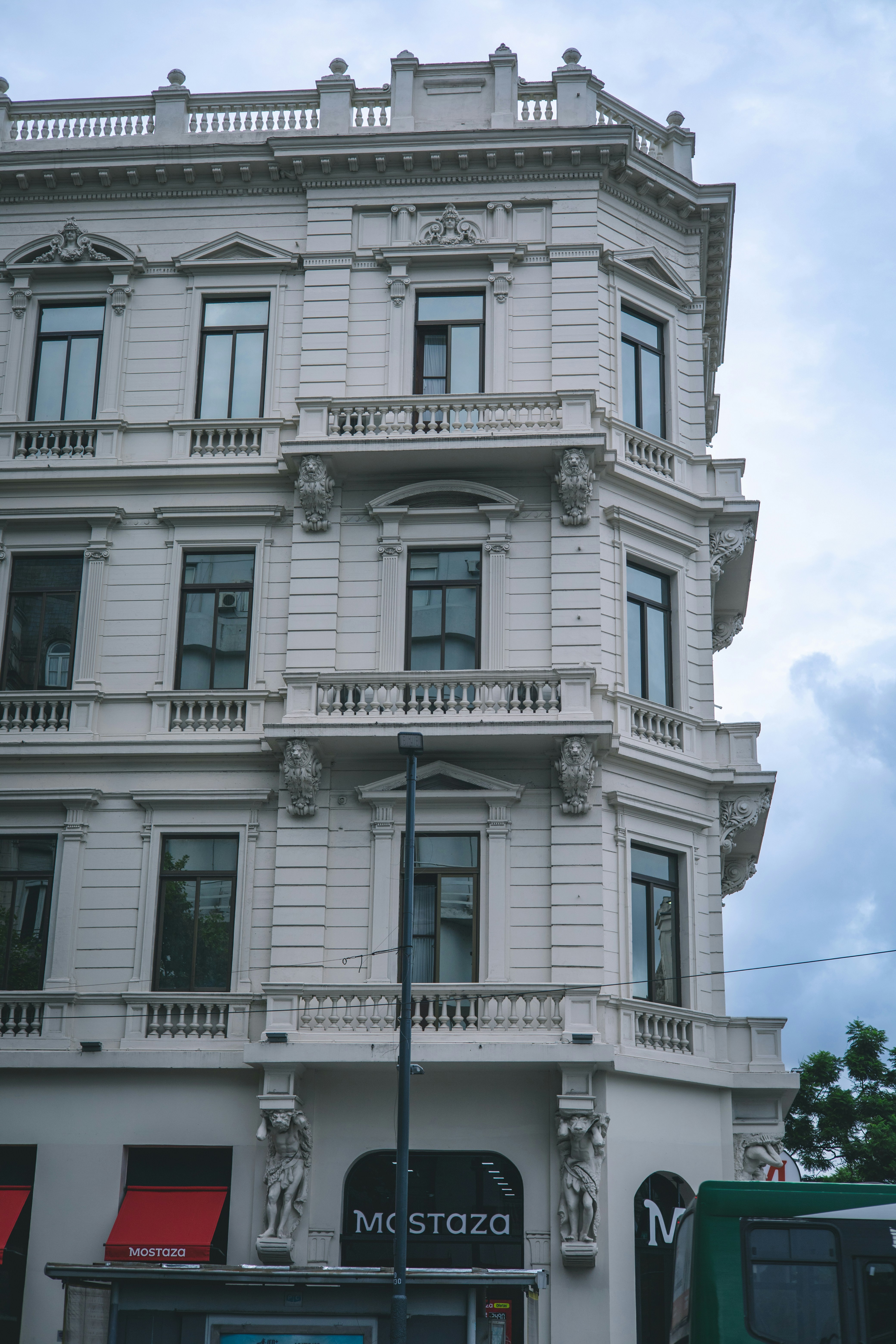 Ornate Cornered Facade: A Classical White Building Reaches Toward the Sky