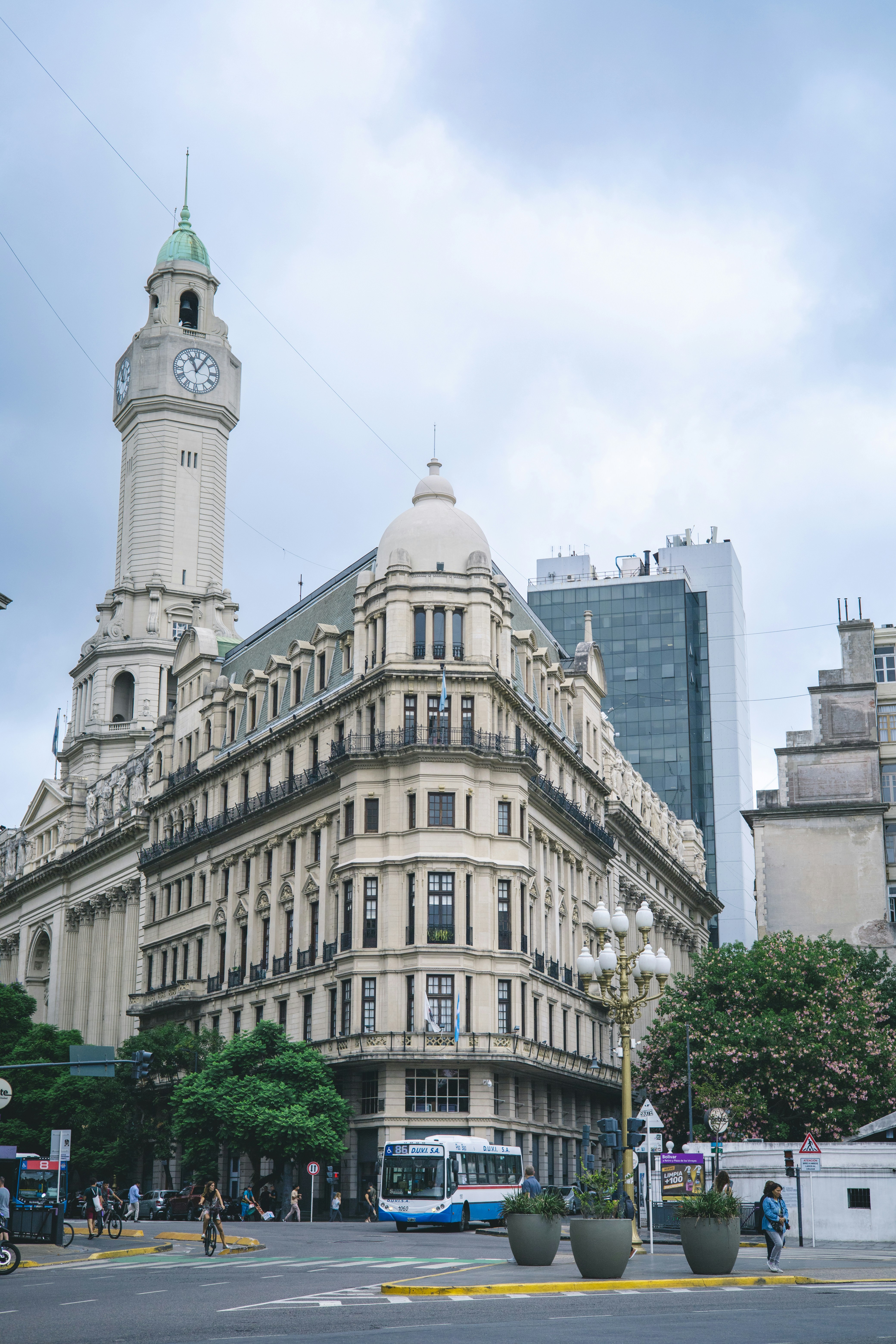 Beaux-Arts Clock Tower Crowned by a Green Spire Over a Historic Corner