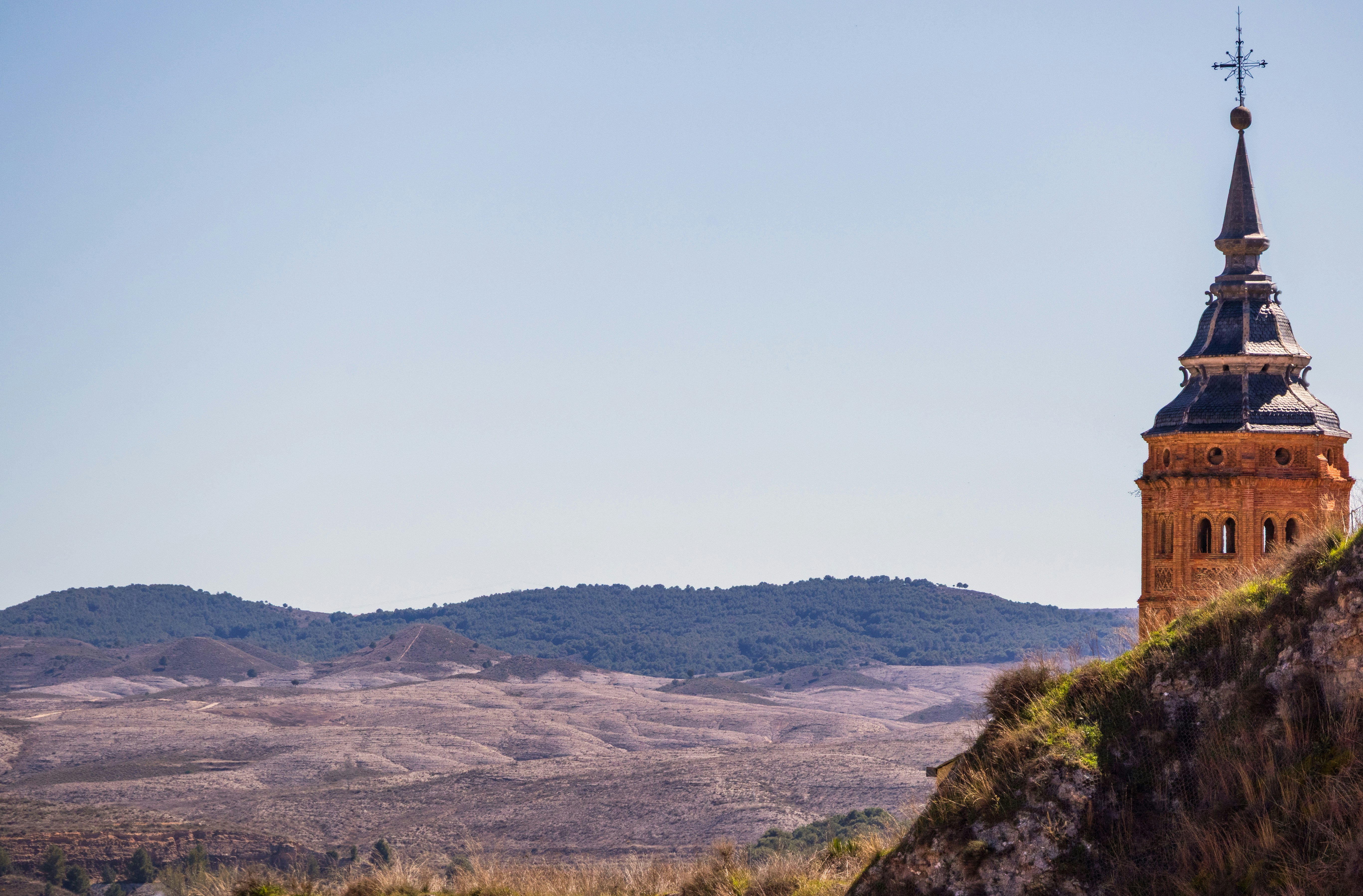 Watchtower Crest: A Lone Structure Amid Rolling Hills