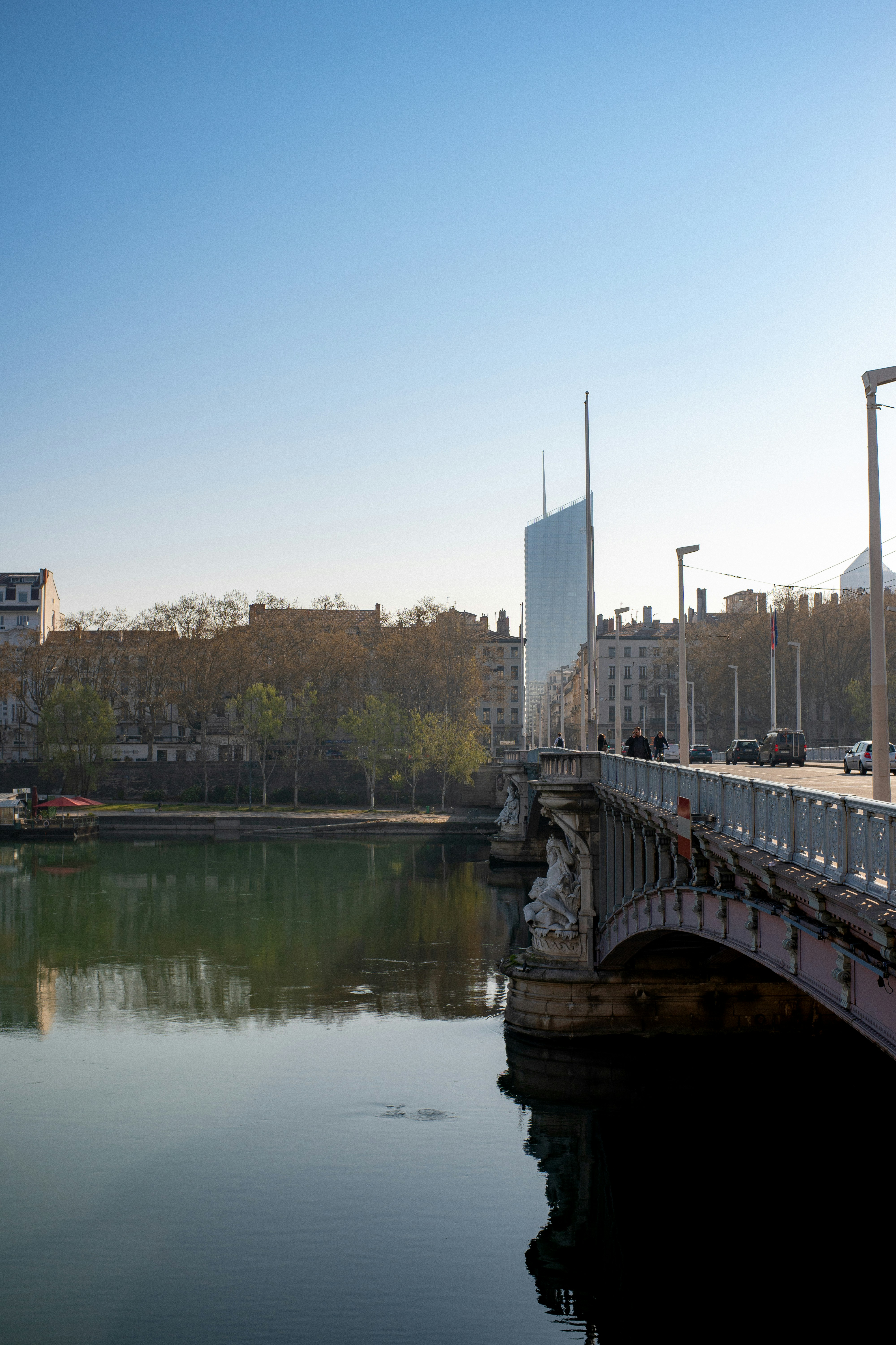Bridge to the City: Morning Light over the Calm River