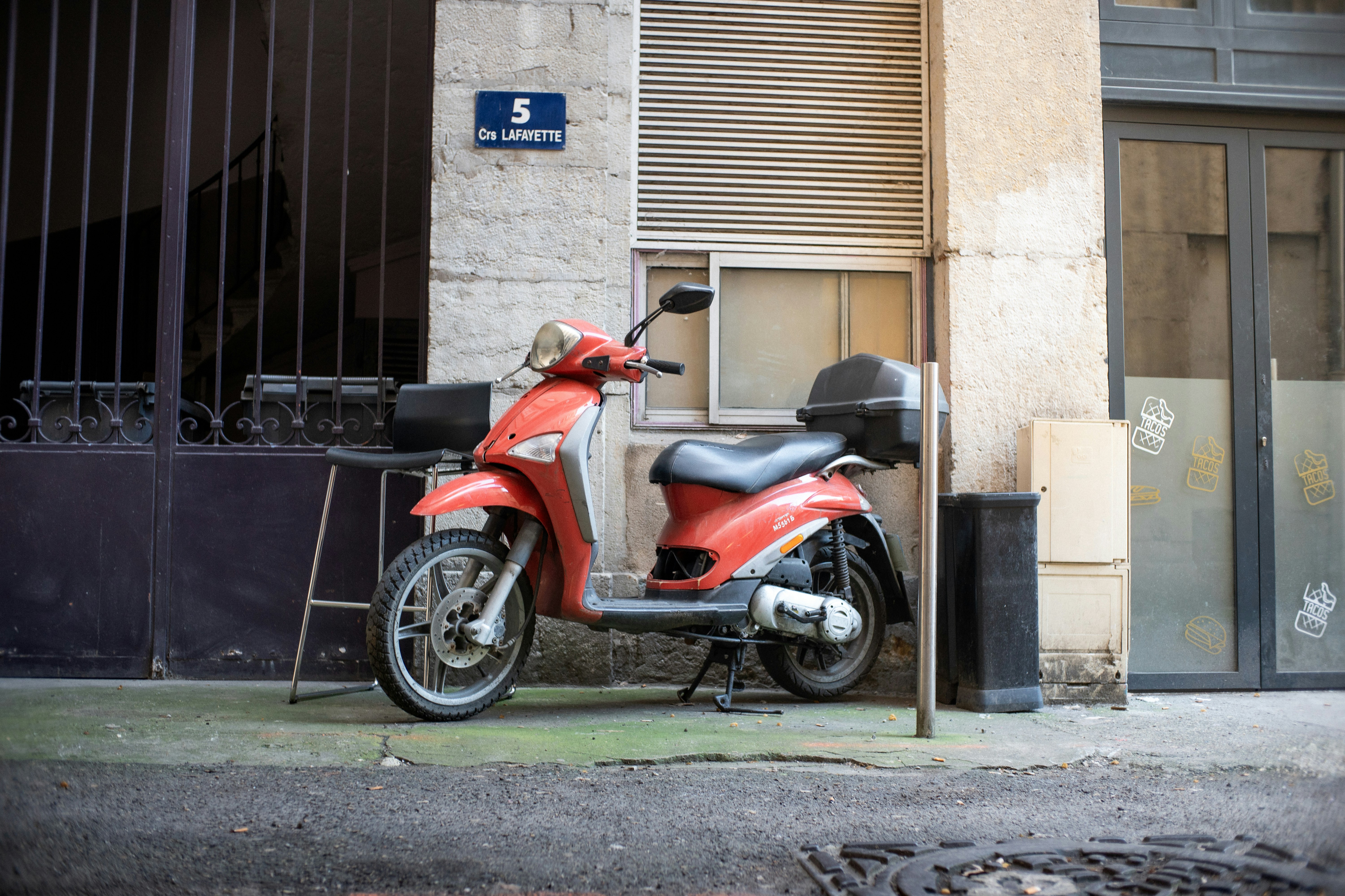 Red Scooter at the Edge of the Street