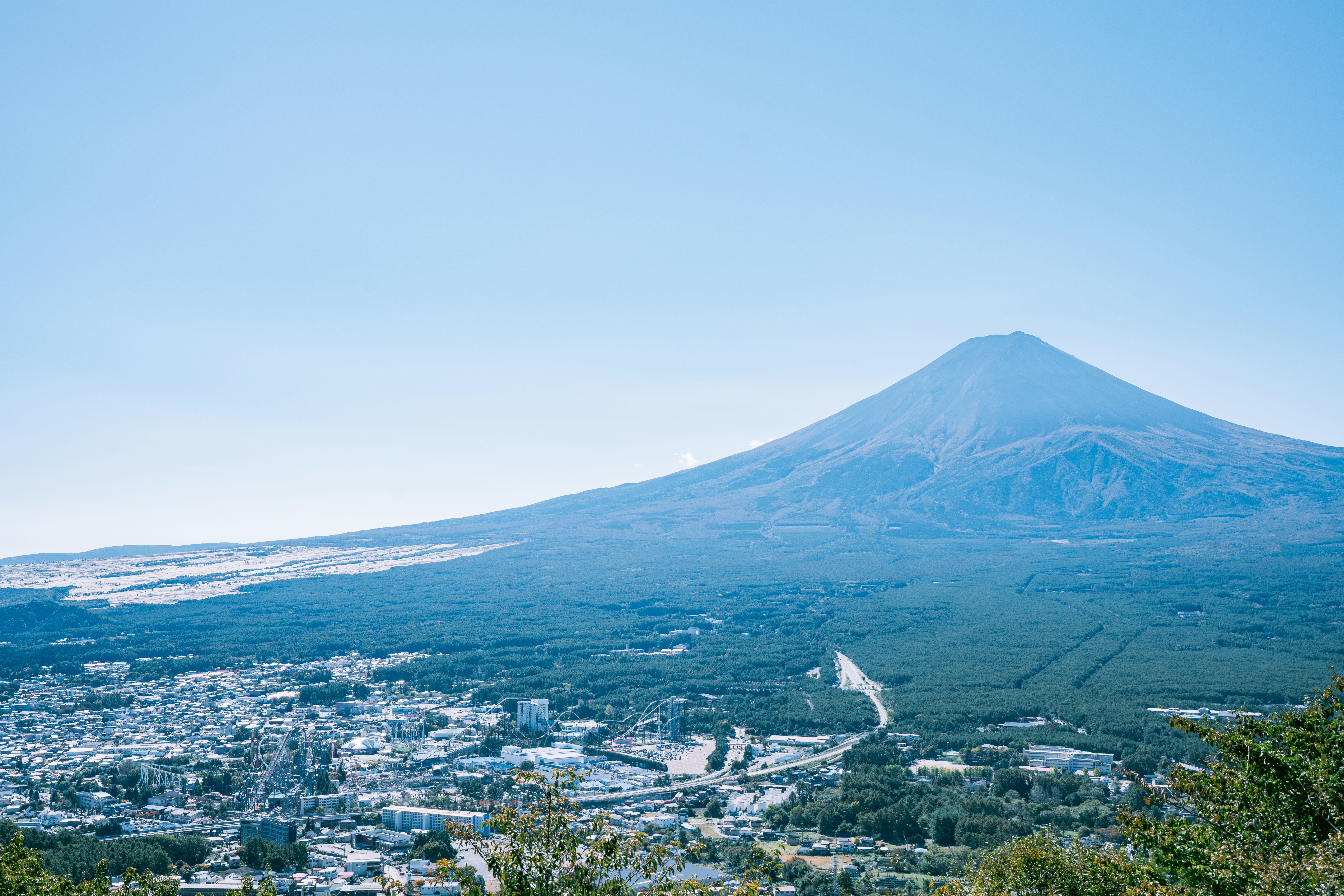 Volcanic Peak Overlook: Suburban Plain Beneath a Looming Cone
