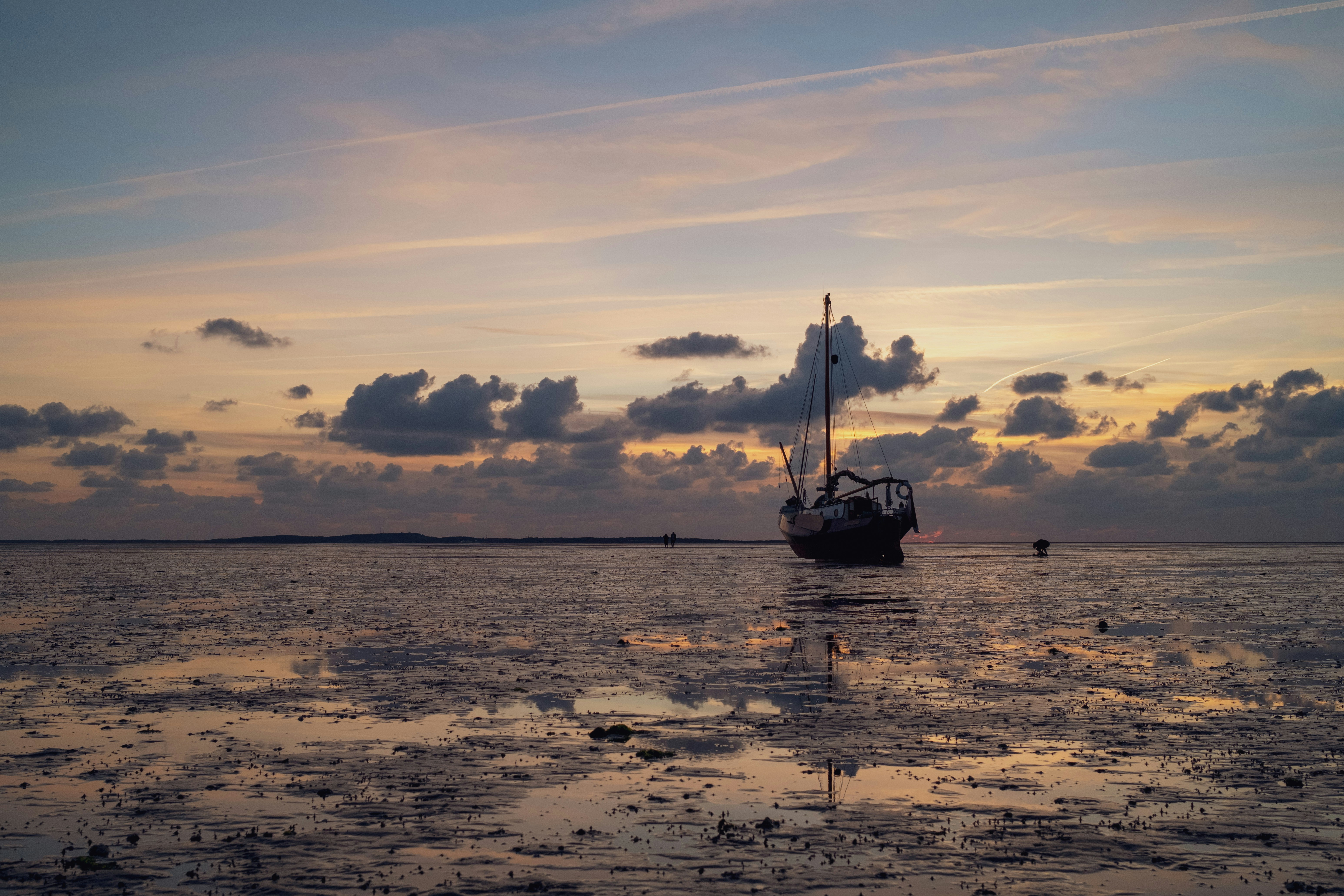 Sailboat at Dusk: Silhouetted Quiet on a Shimmering Tide