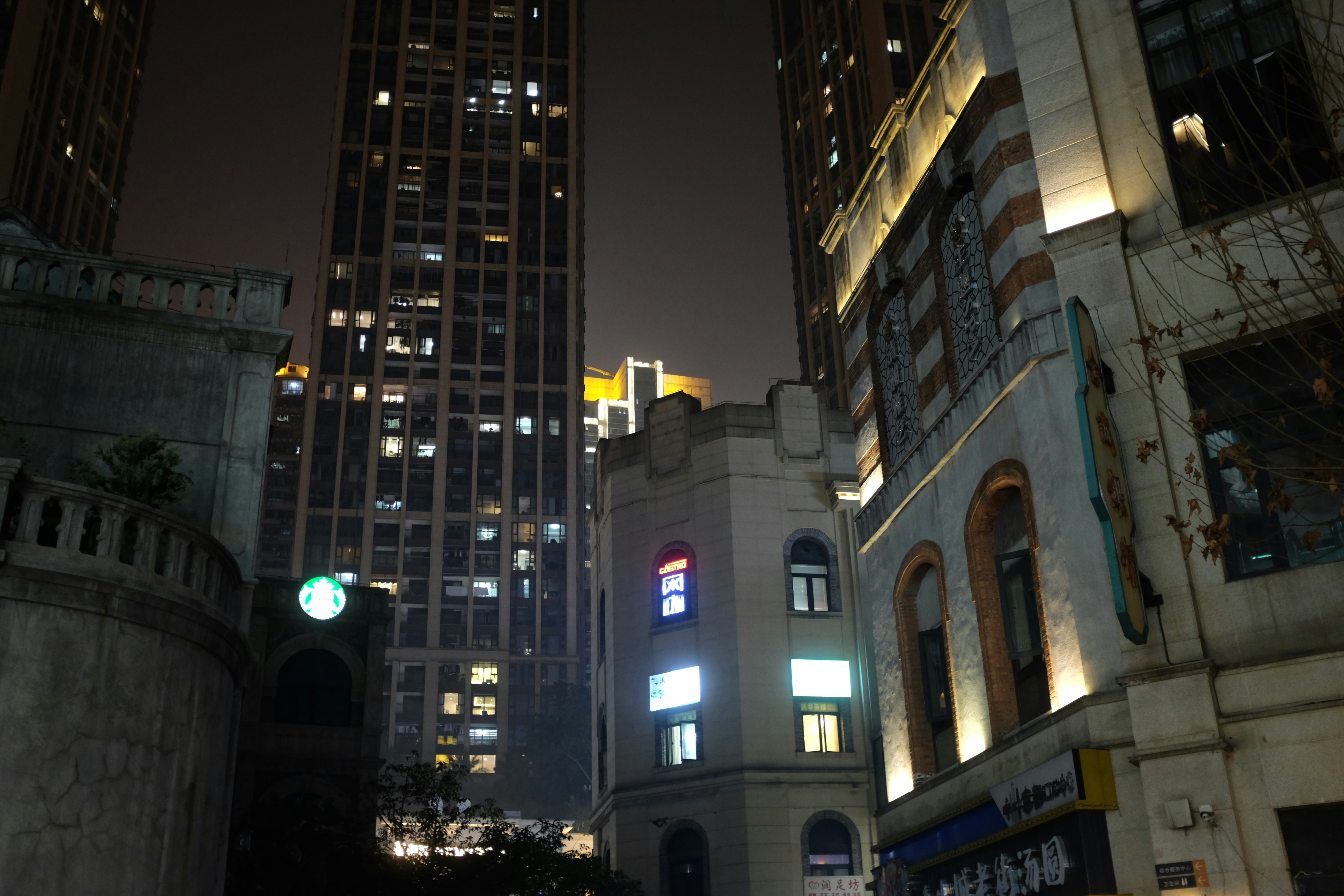 Nighttime Urban Mosaic: Facades, Neon, and Cast Shadows