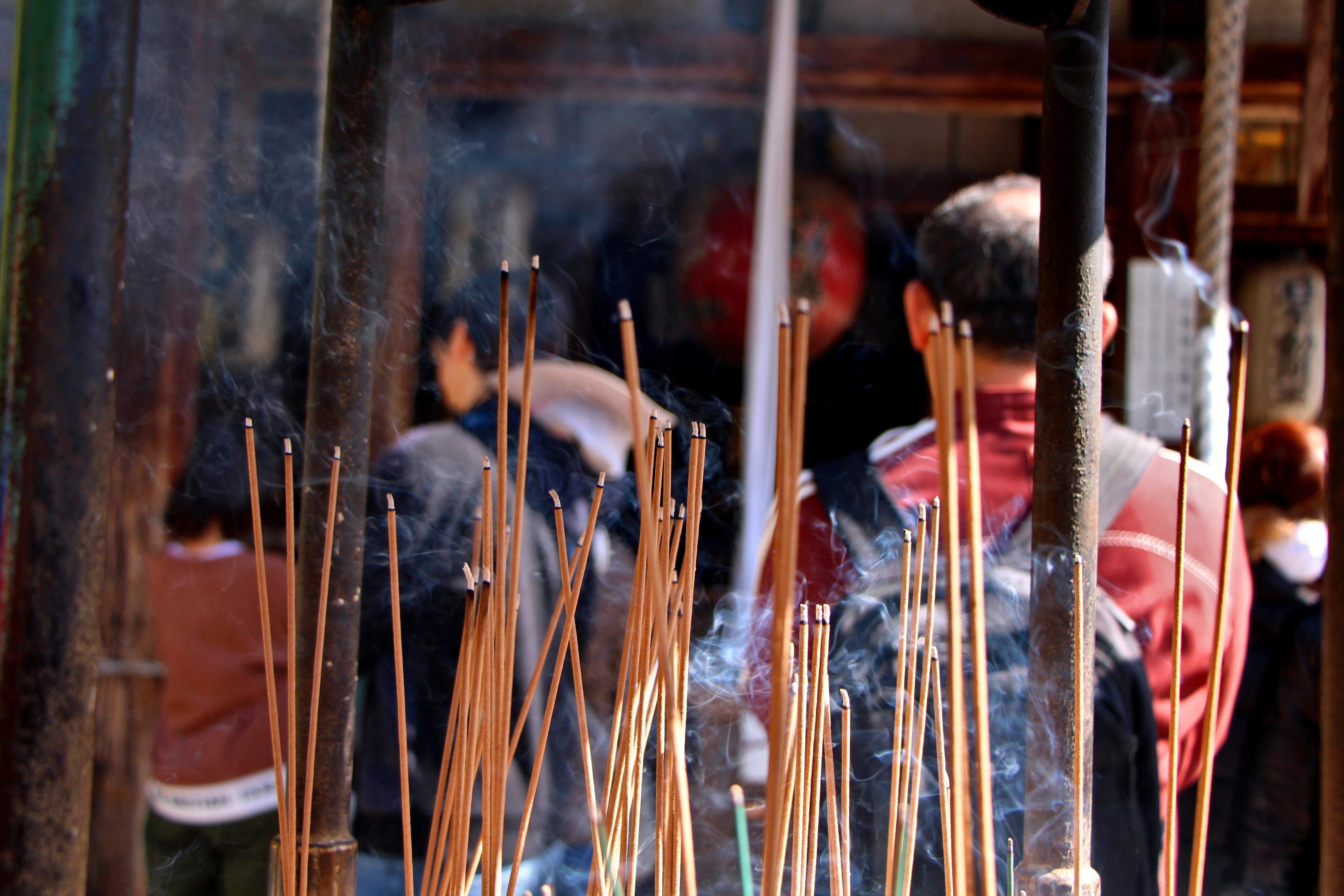 Incense Corridor: Clusters of Smoldering Sticks in a Busy Market