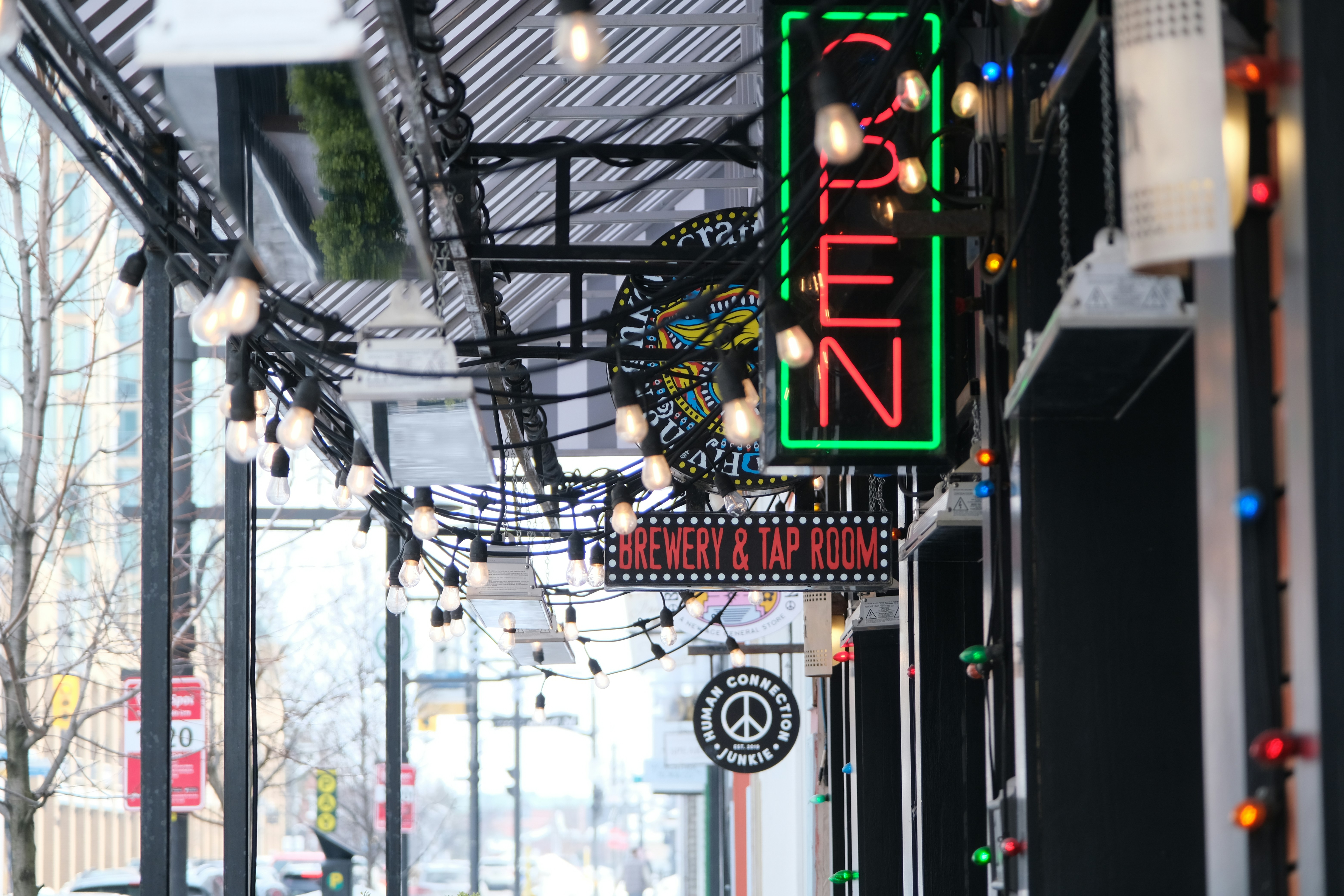 Neon Promenade: A Busy Street Beneath Strings of Globe Lights