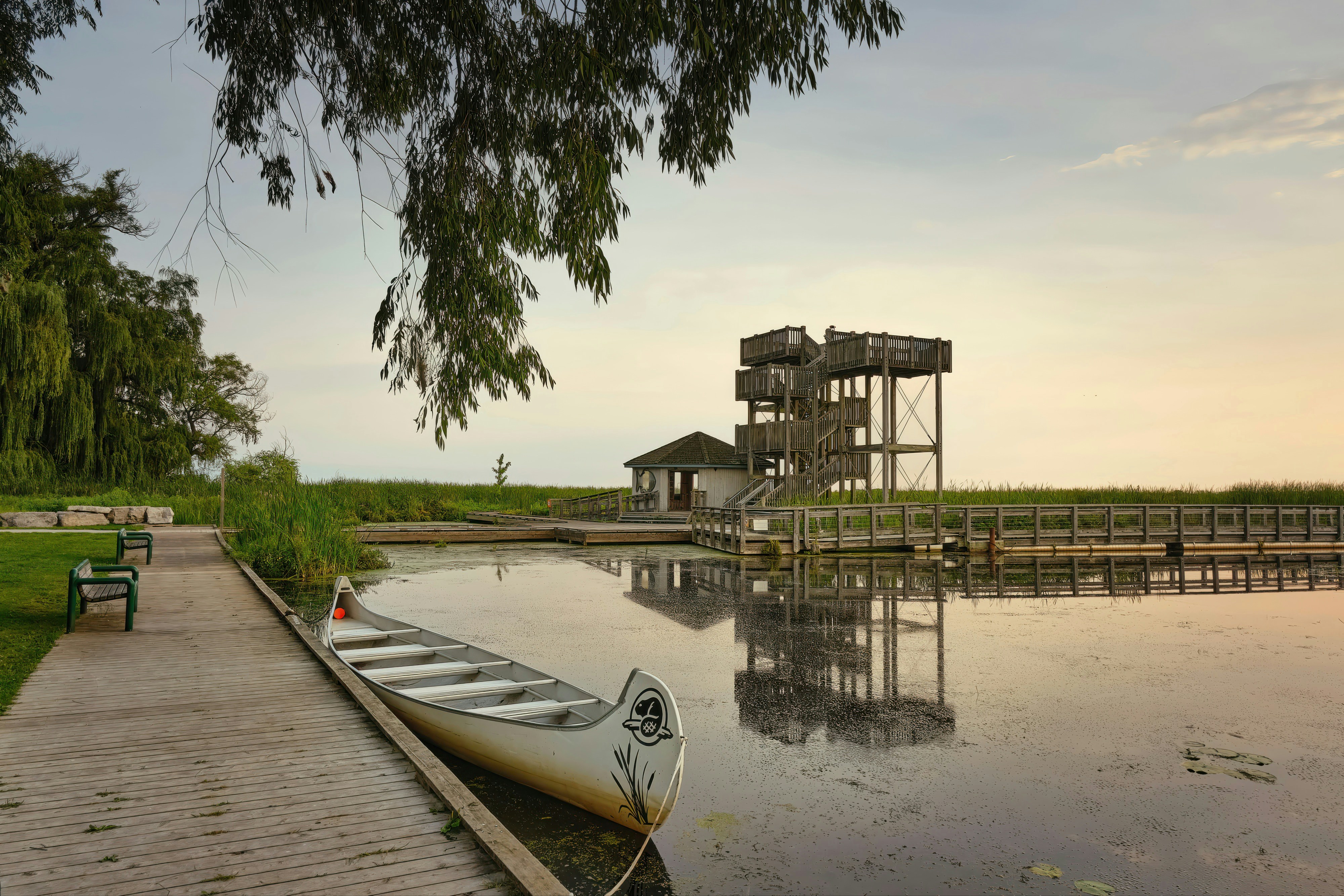 Dusk at the Wharf: A Silent Boat and Tower by the Water