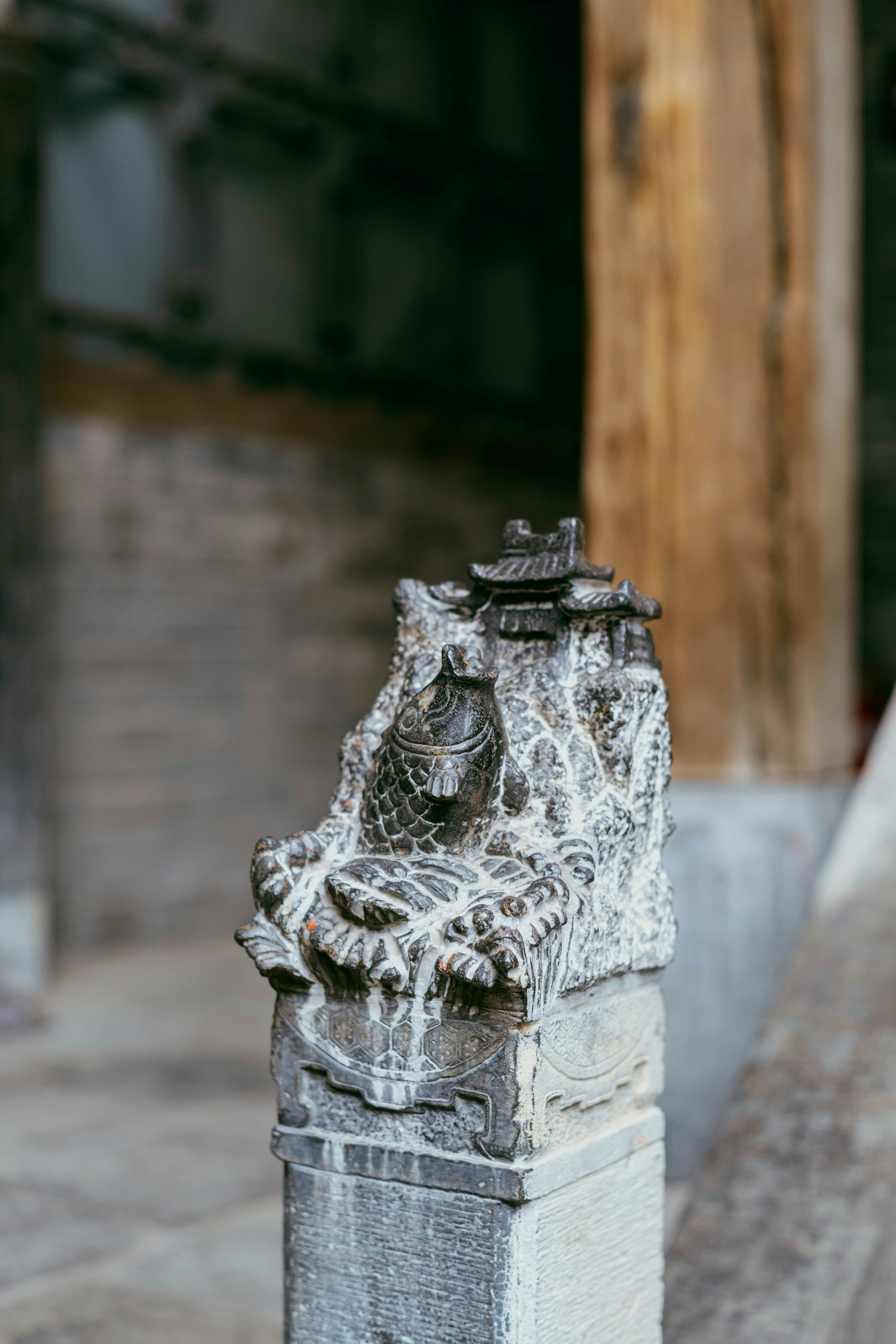 Stone Dragon Sentinel: A Weathered Carving Piercing the Quiet Atrium