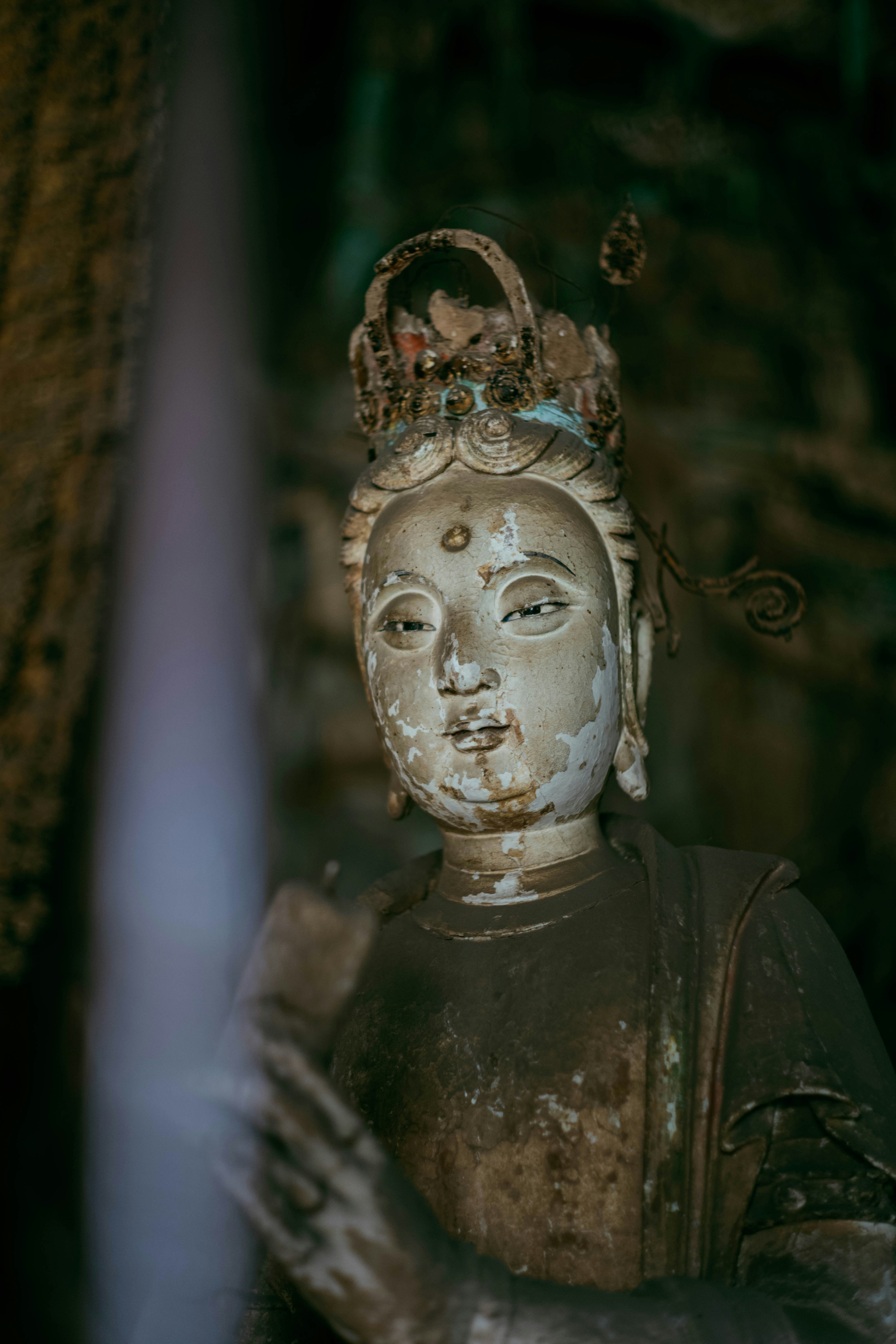 Weathered Bodhisattva: A Silent Gaze Beneath Timeworn Layers