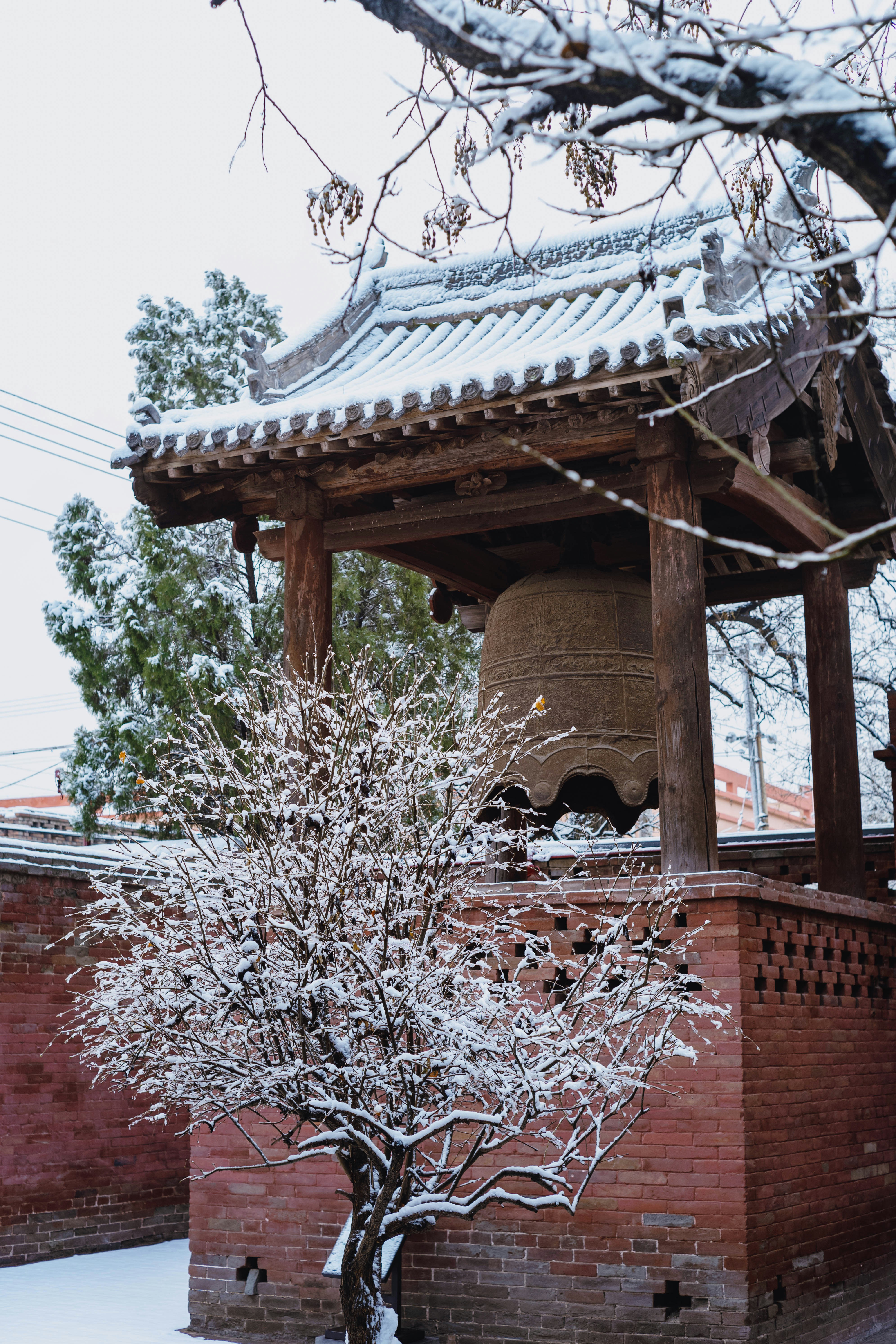 Snow-Blanketed Bell Gate: Quiet Pagoda Under Winter Frost
