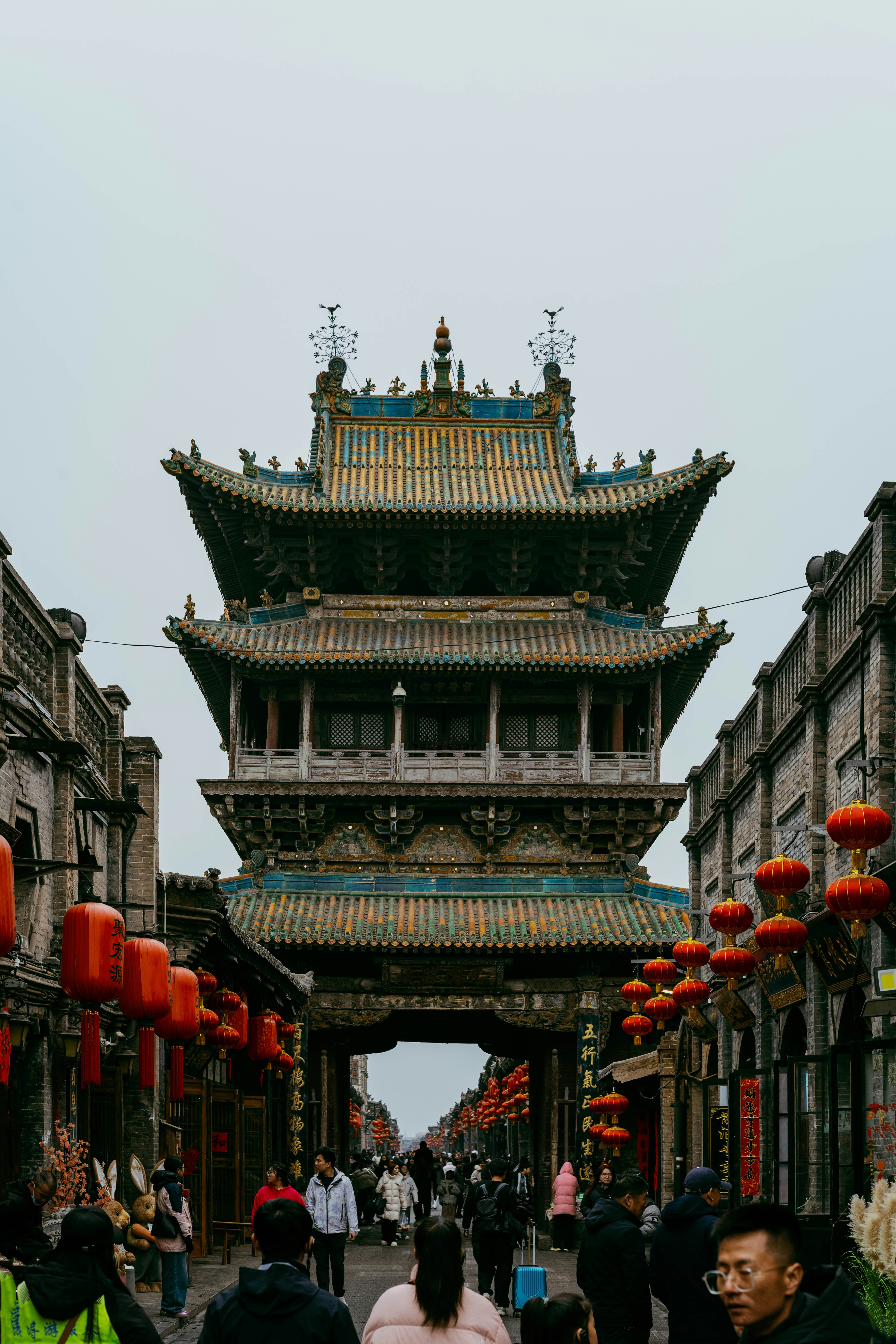 Ancient Gateways: Lantern-lit Street Framing a Historic Pagoda