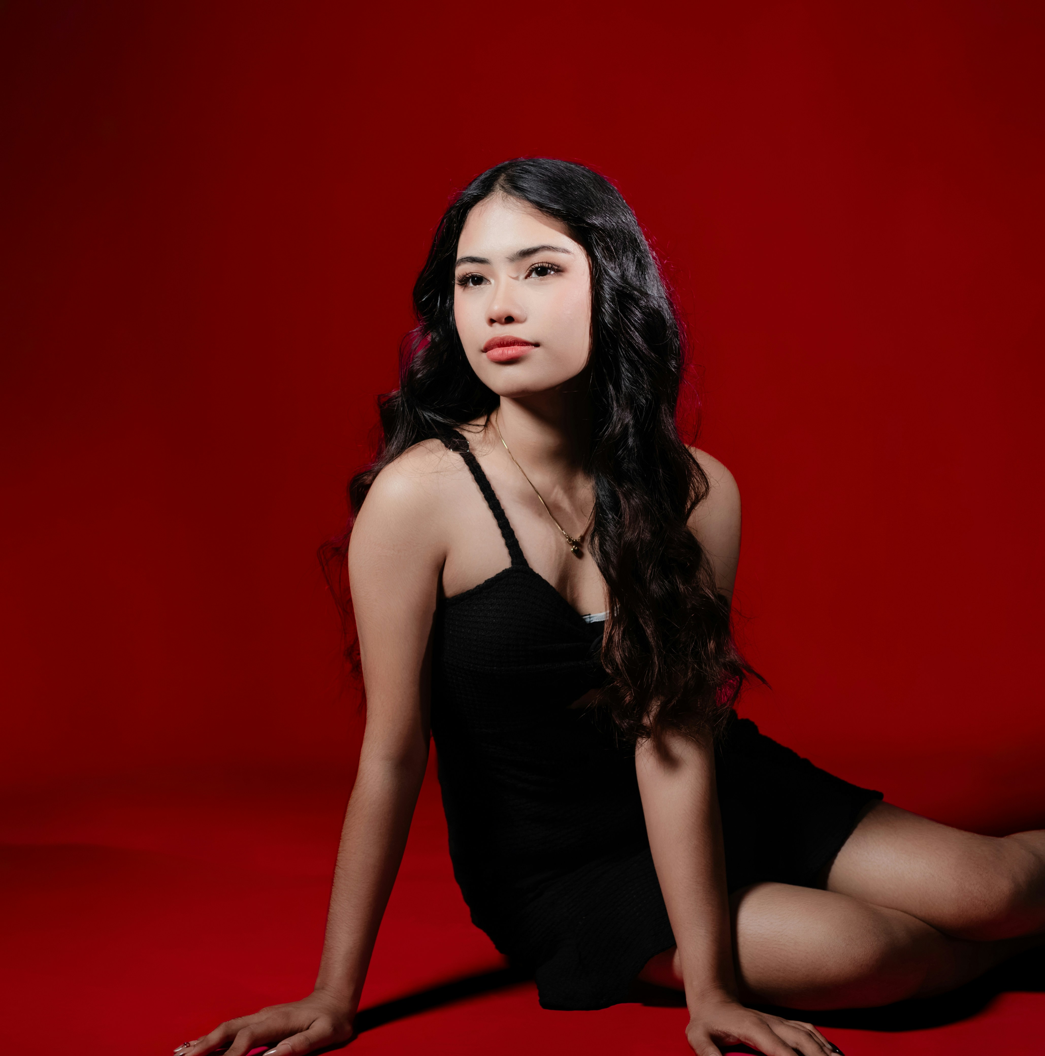 Red Velvet Gaze: Studio Silence Against a Scarlet Backdrop