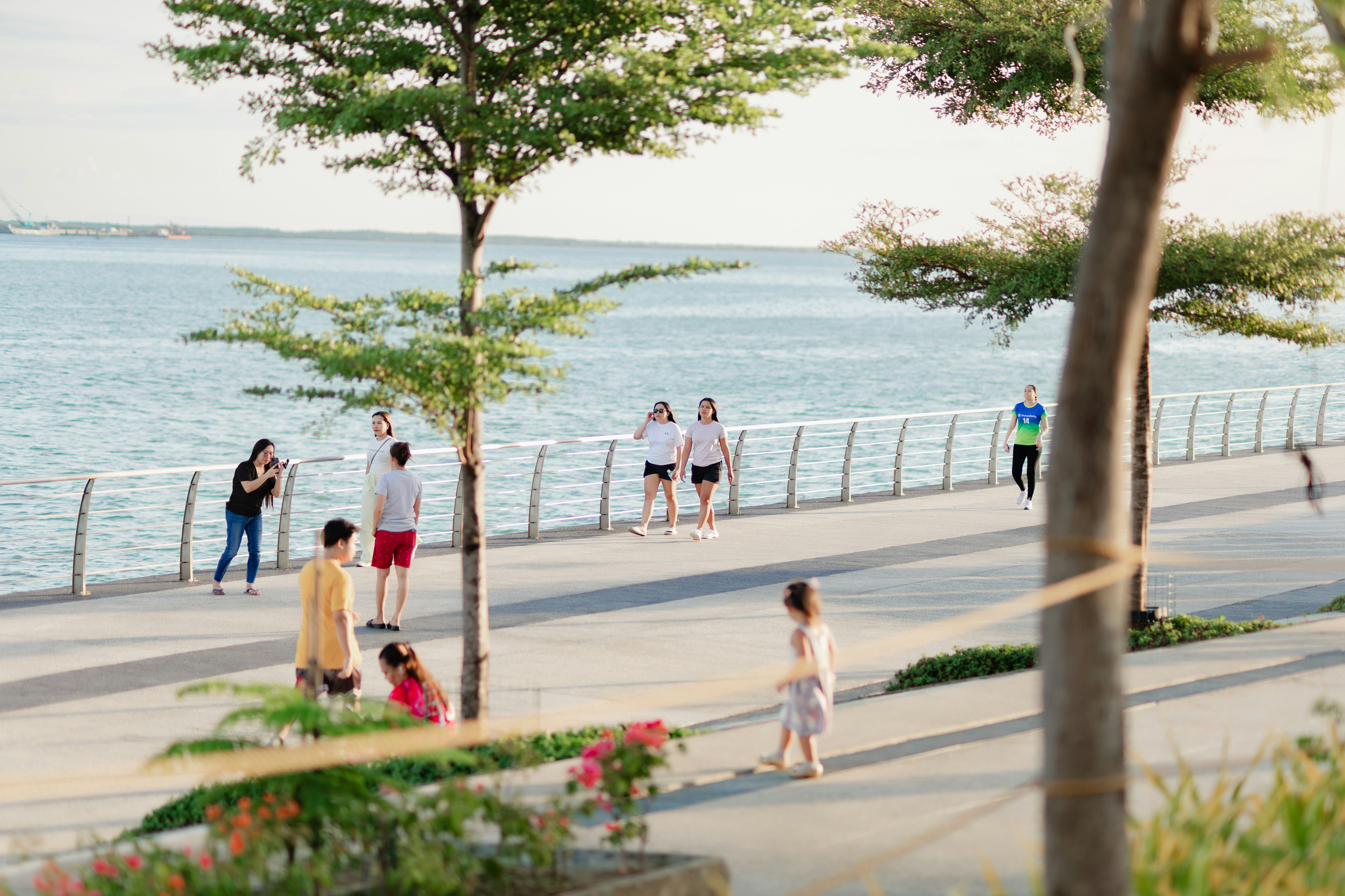 Sunlit Seaside Promenade: A Lively Coastal Stroll