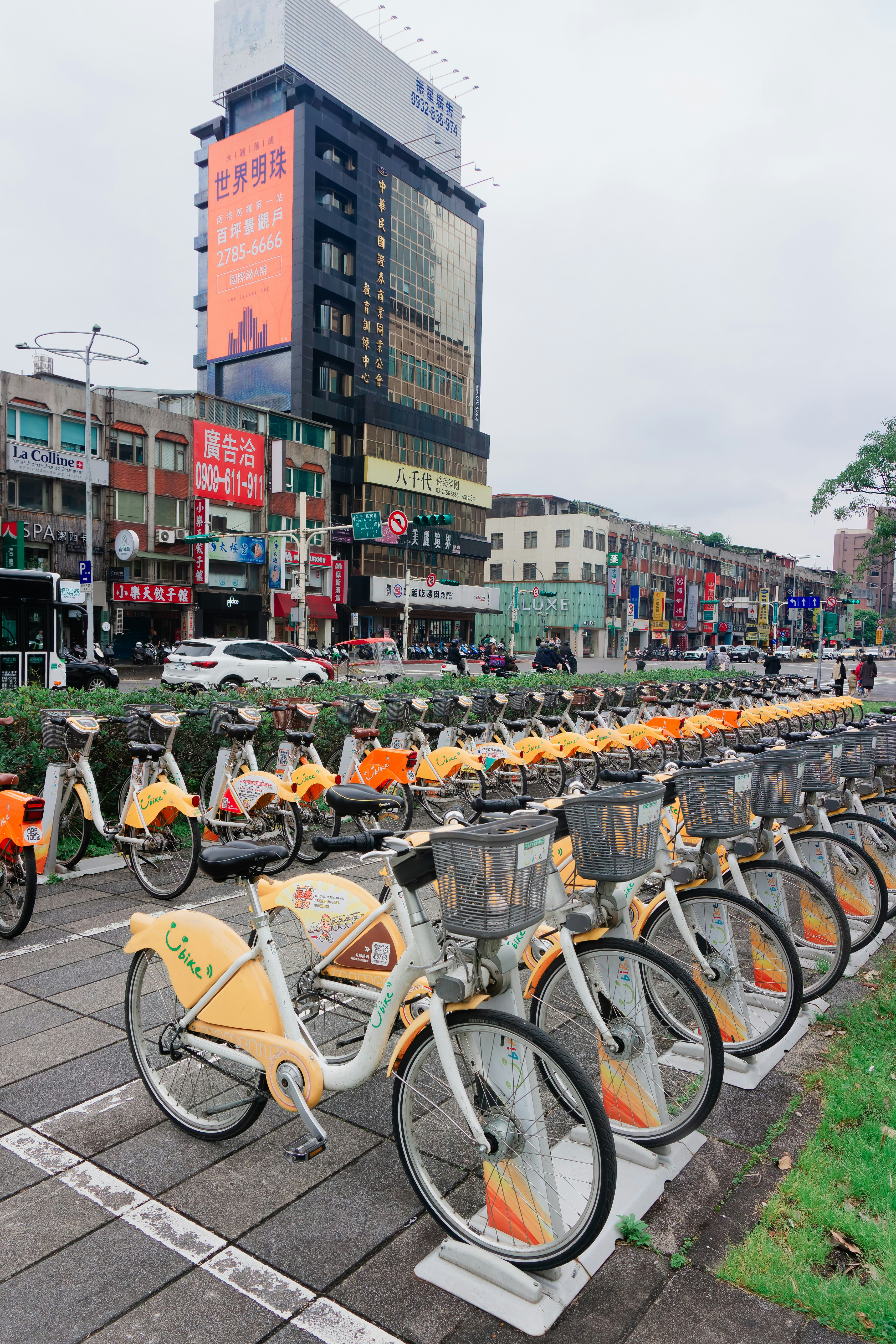 Row of vibrant rental bikes align along an urban street market scene