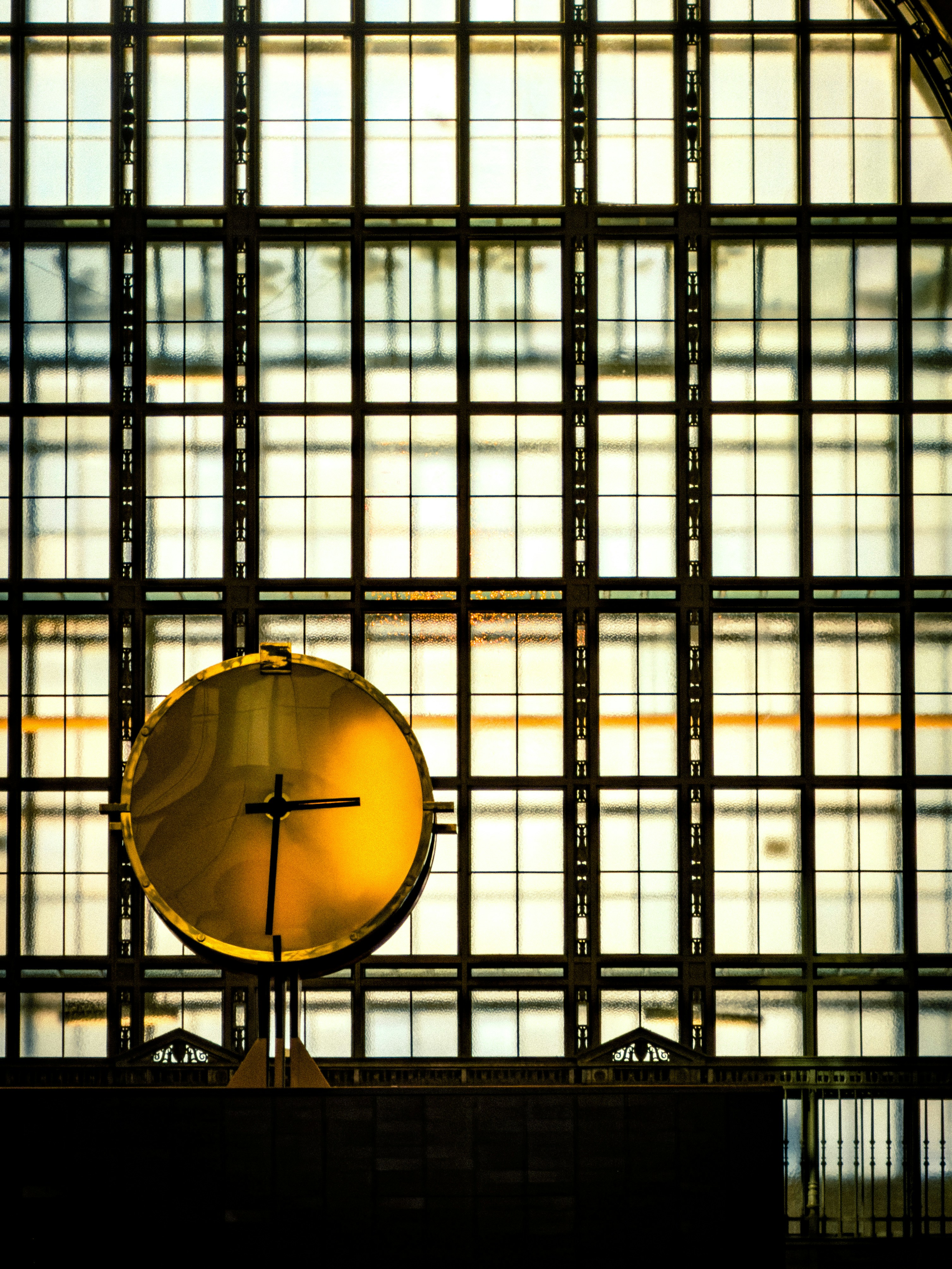 Golden Timekeeper Beneath a Grid of Glass