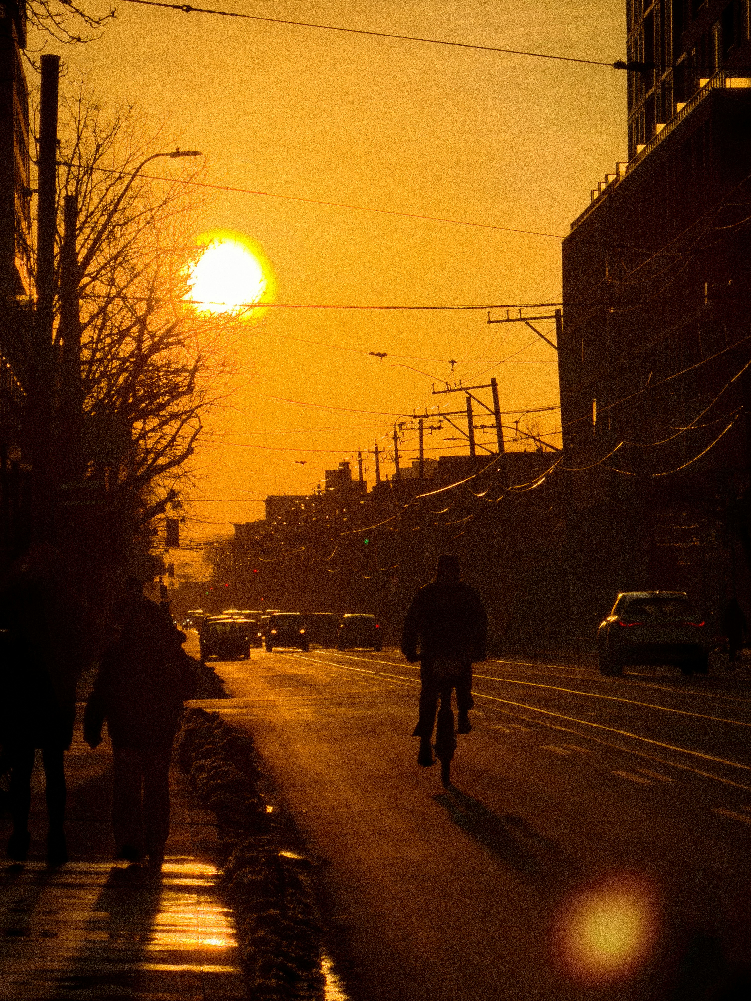Sunlit Street Sojourn: A City Dusk with Moving Silhouettes