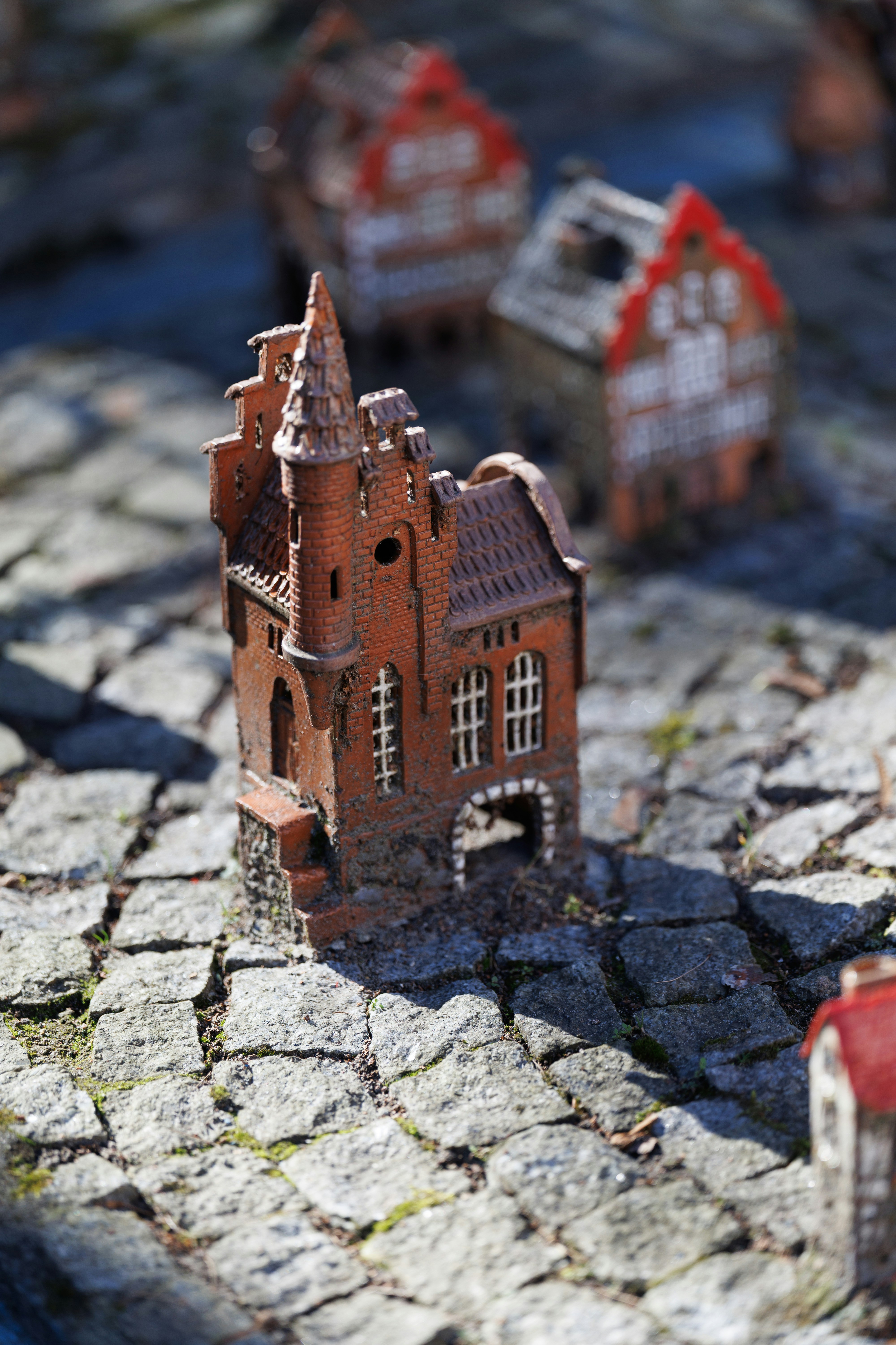 Miniature Fortress on Cobblestones: A Cluster of Tiny Brick Castles