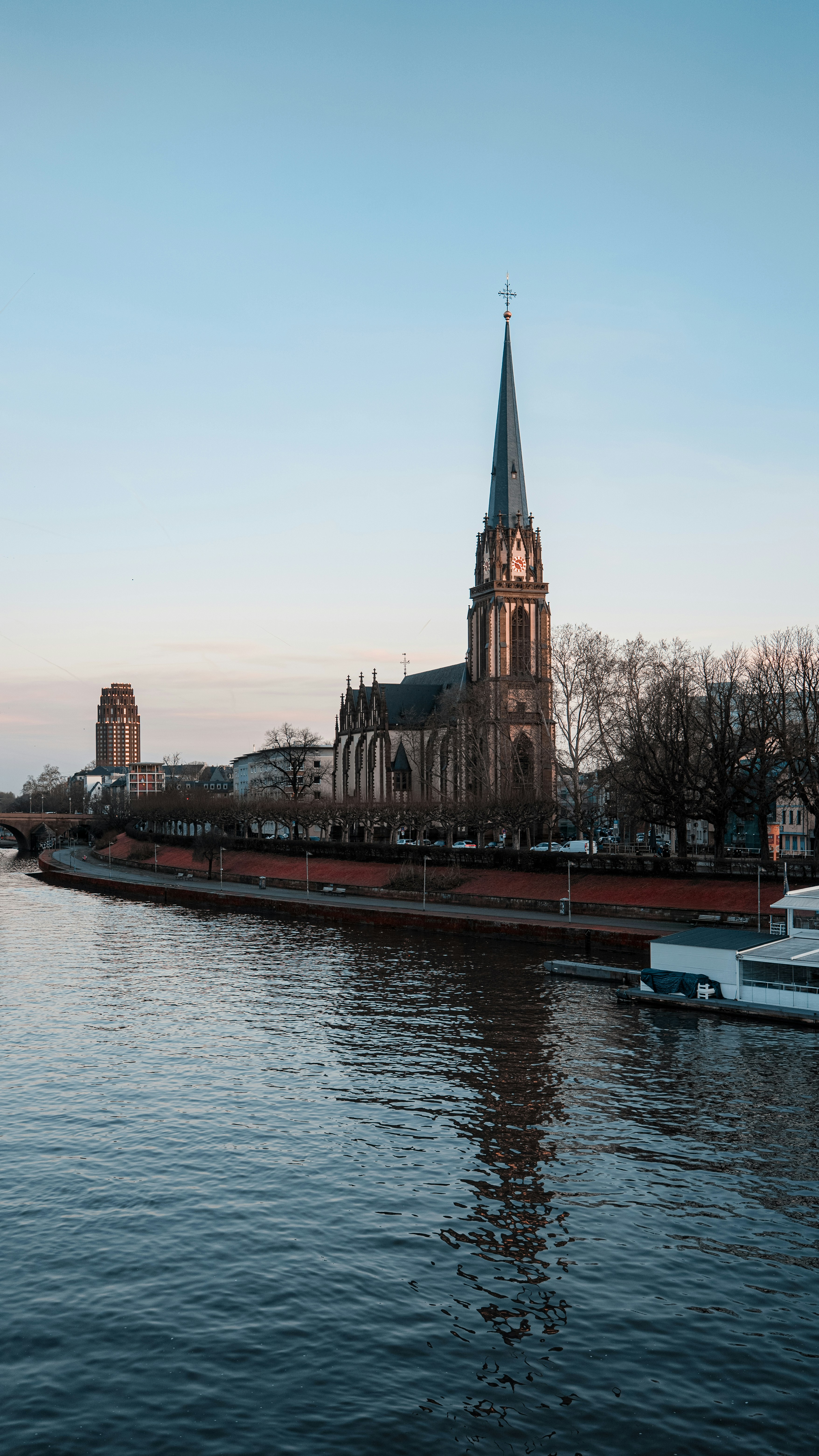 St. Spire by the River: A Gothic Cathedral Framed by Dusk