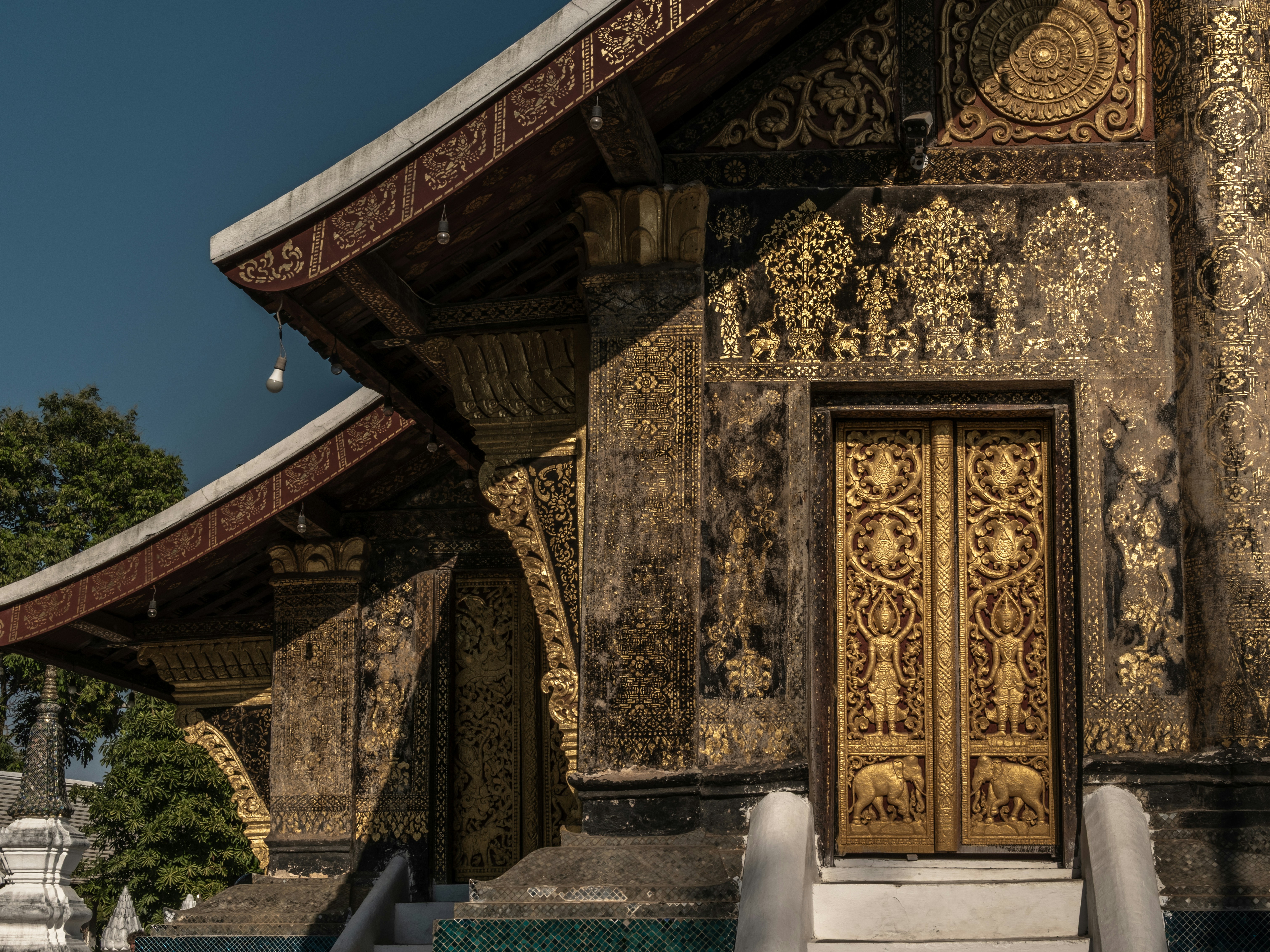 Gold-embossed doorway under carved temple eaves