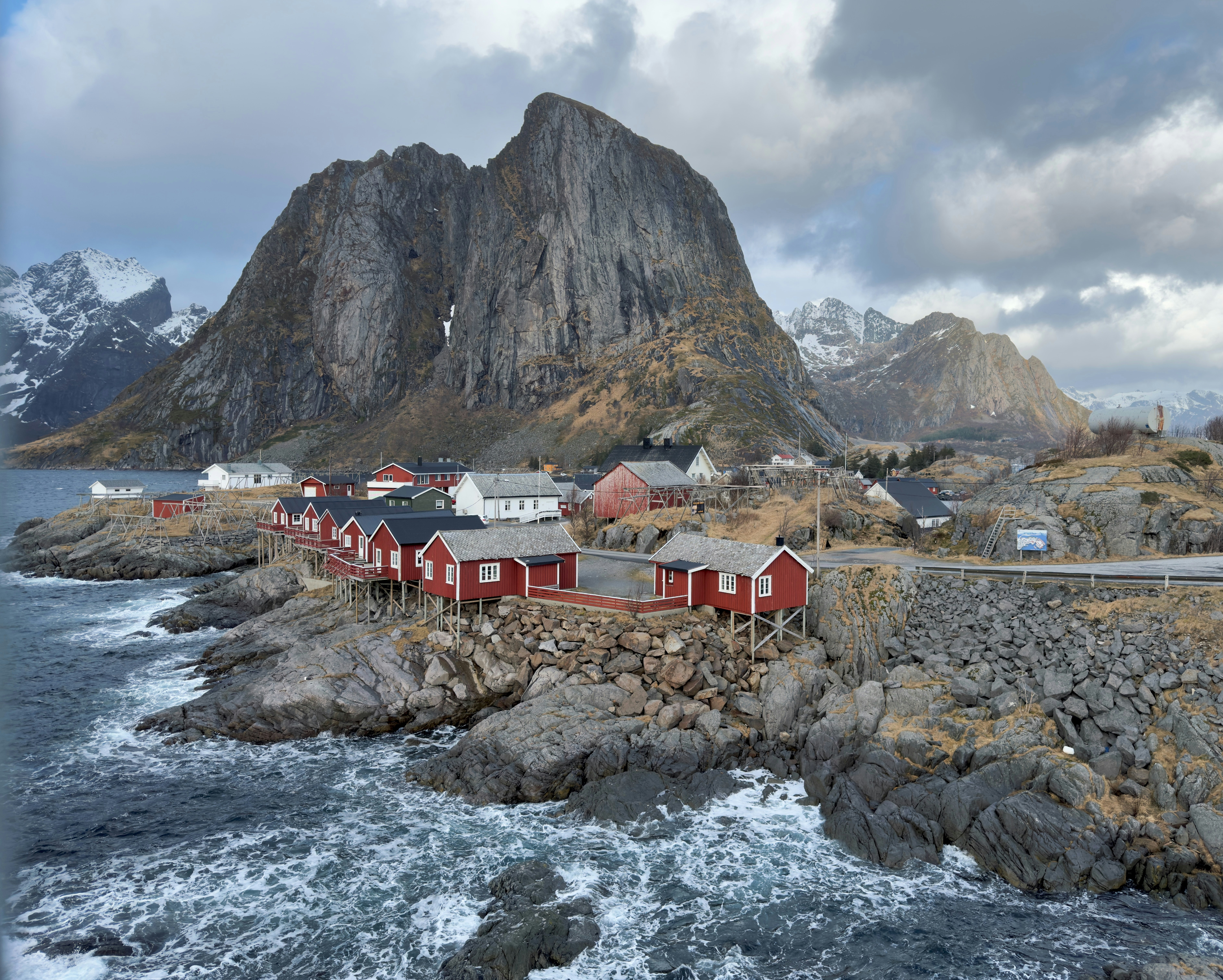 Red Atlantic Outpost Nestled at the Foot of a Towering Granite Cliff