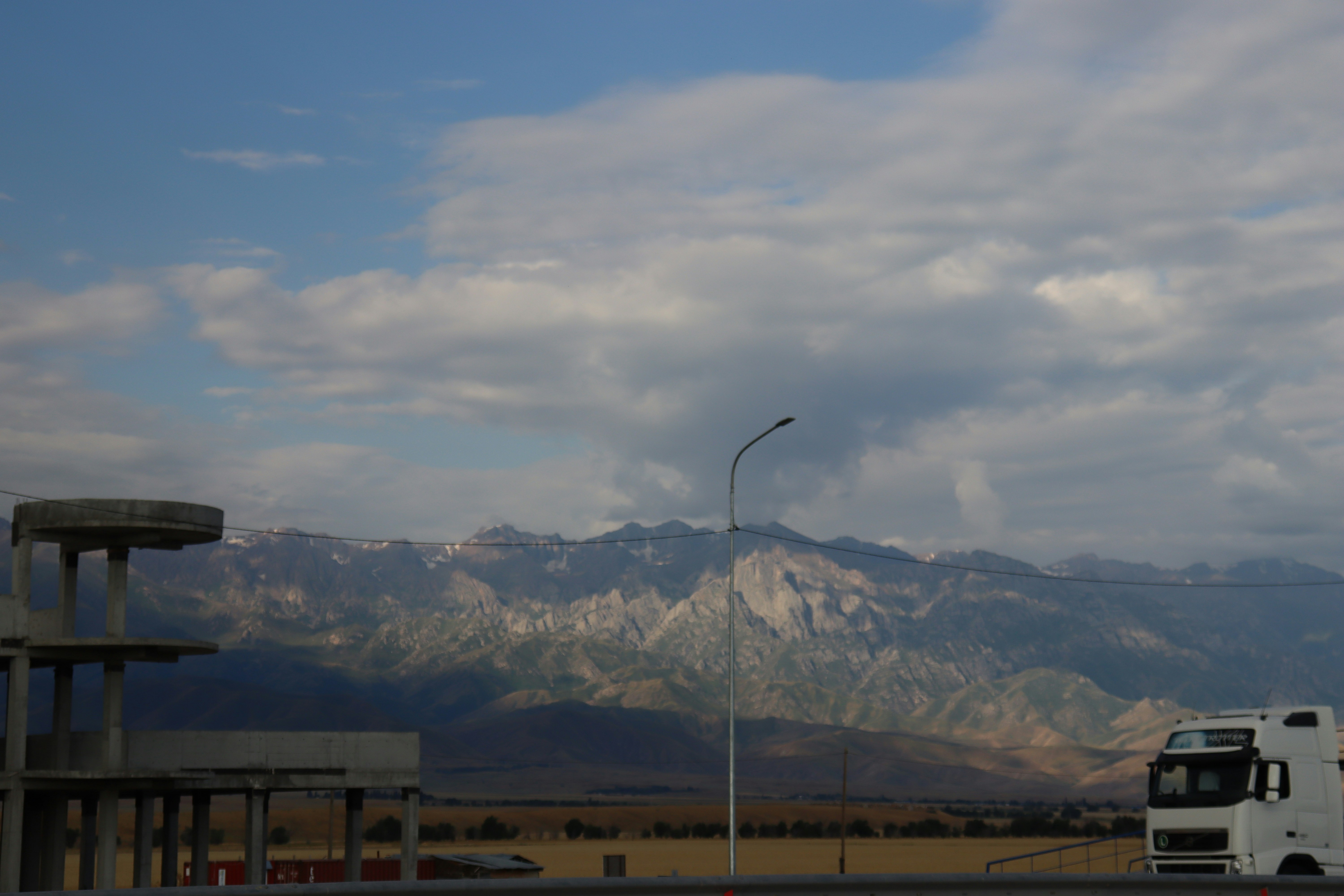 Highway Vistas Under Broad Blue: Mountains on the Horizon