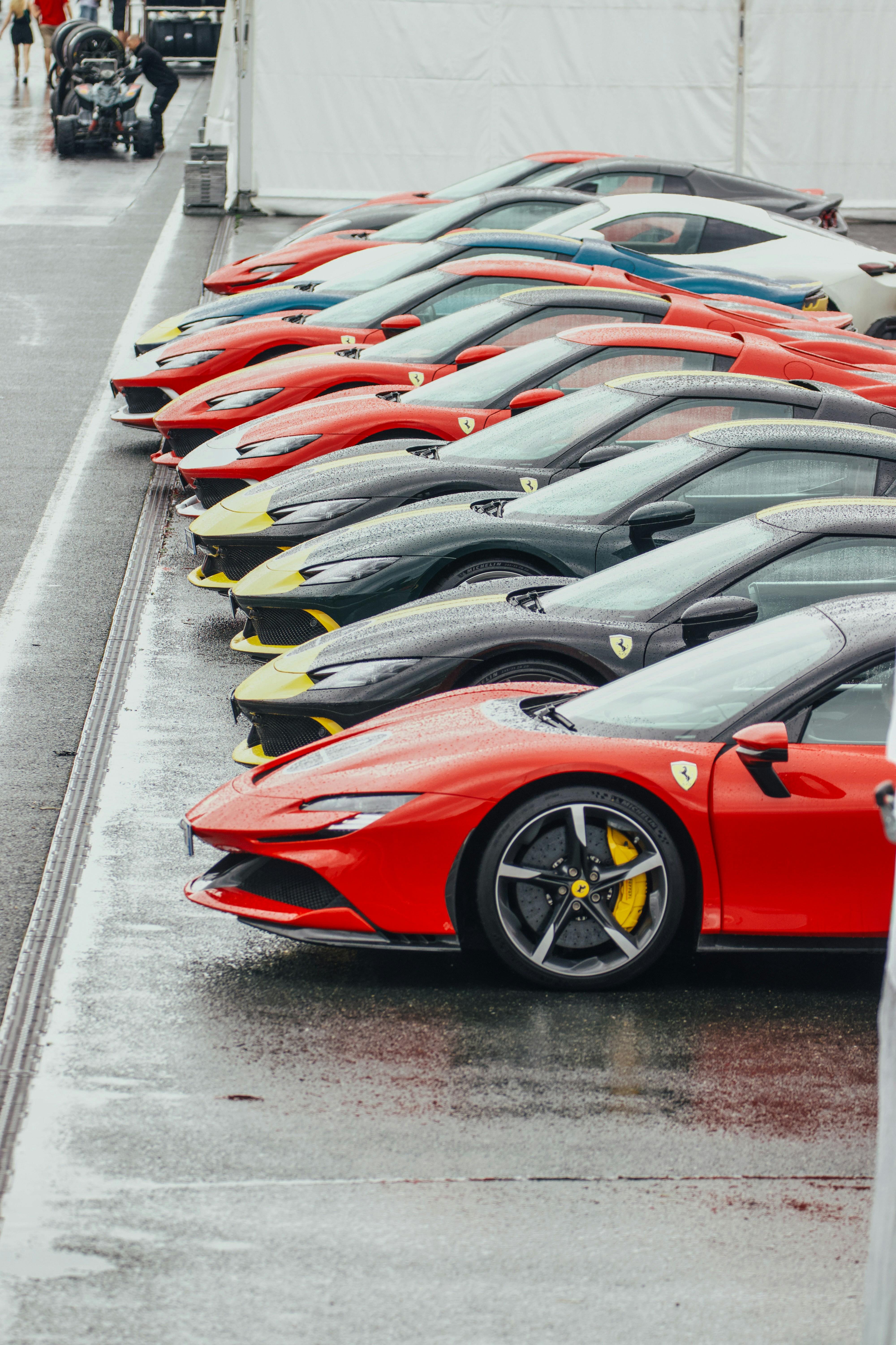 Row of Red Ferraris: Lineup Under Rain on the Track