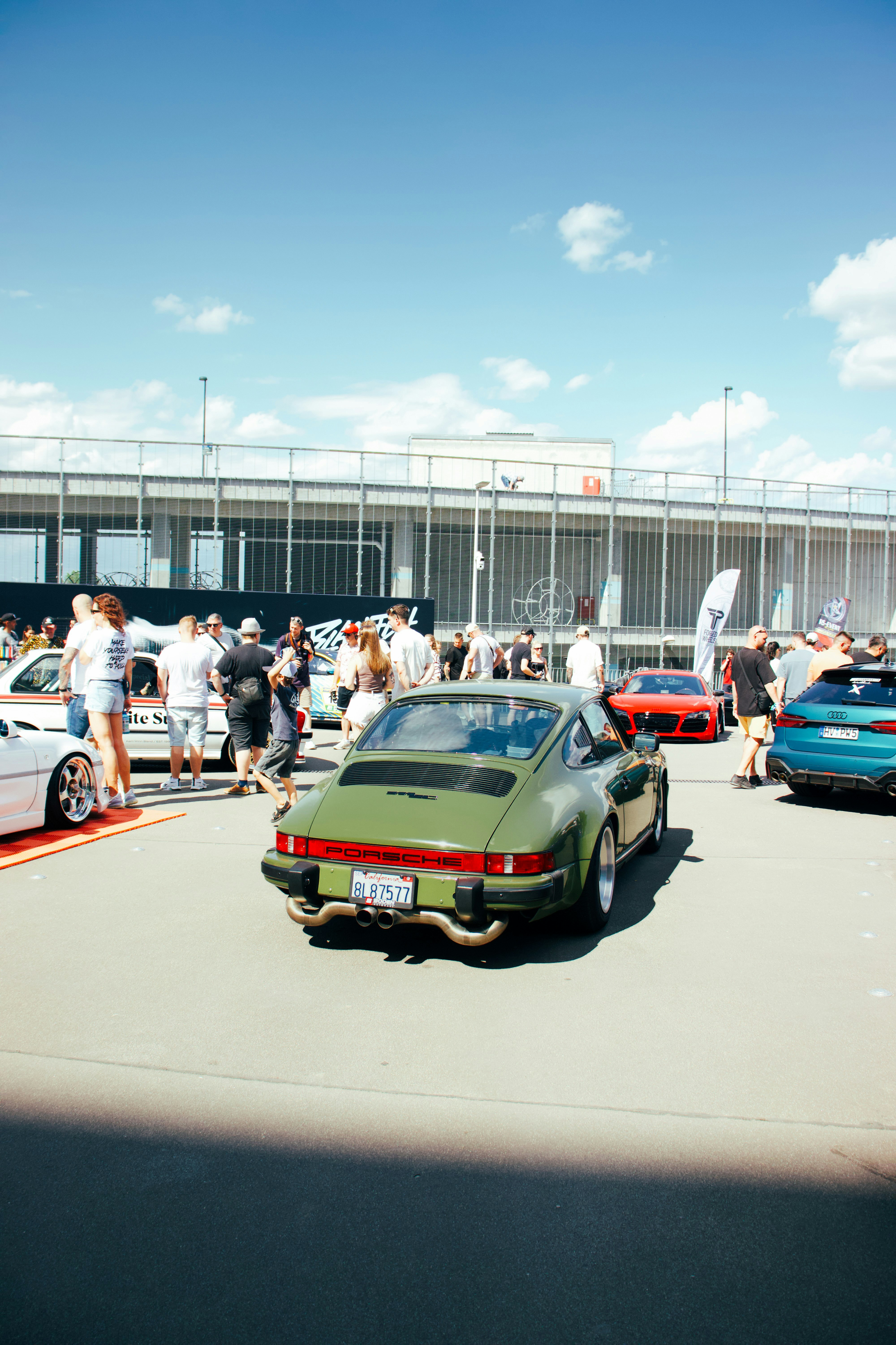 Green Porsche Between Watches: A Car Cultured in Sunlit Car Show