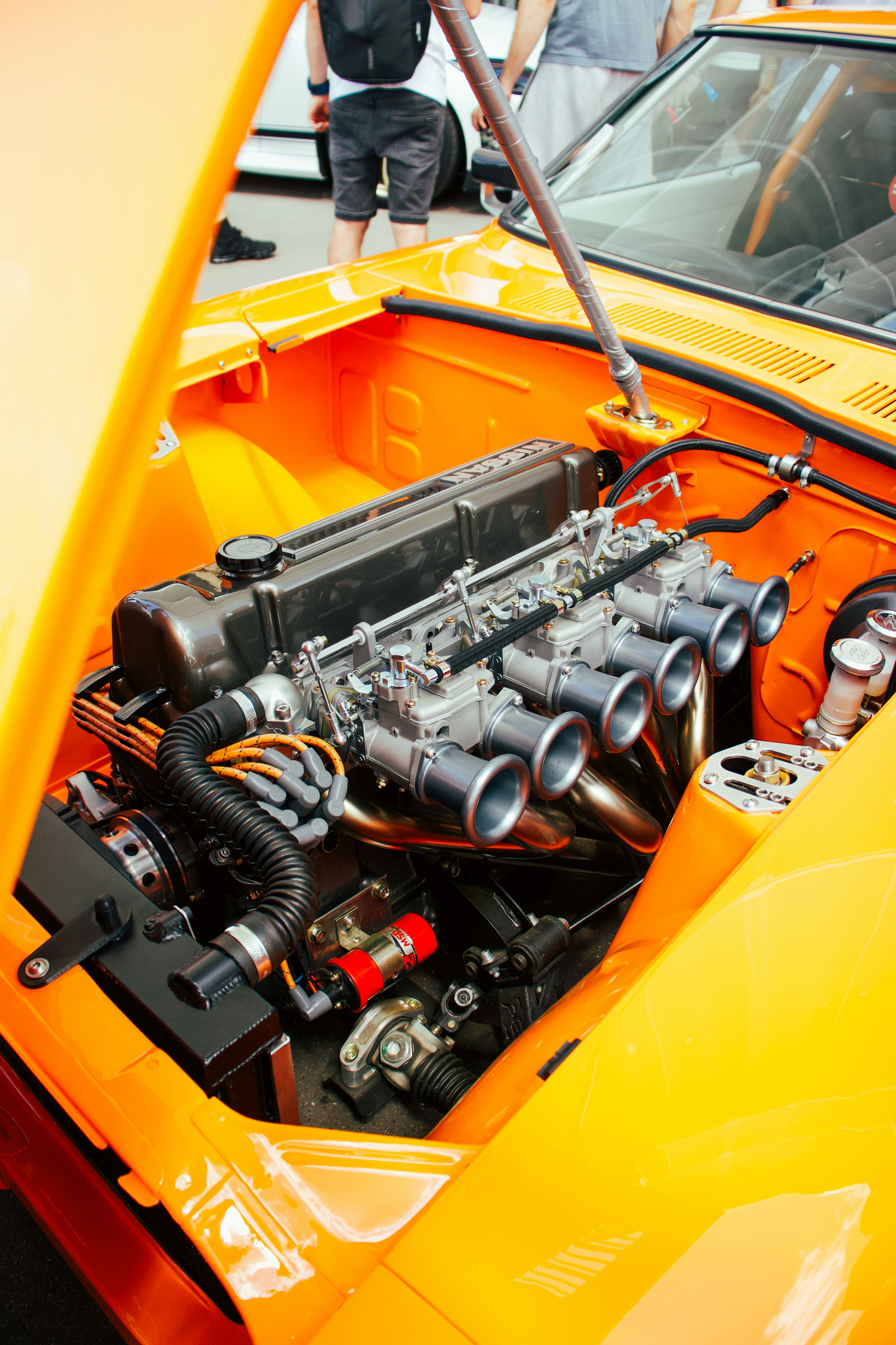 Orange Car Engine: a vivid close-up of an exposed vintage powerplant