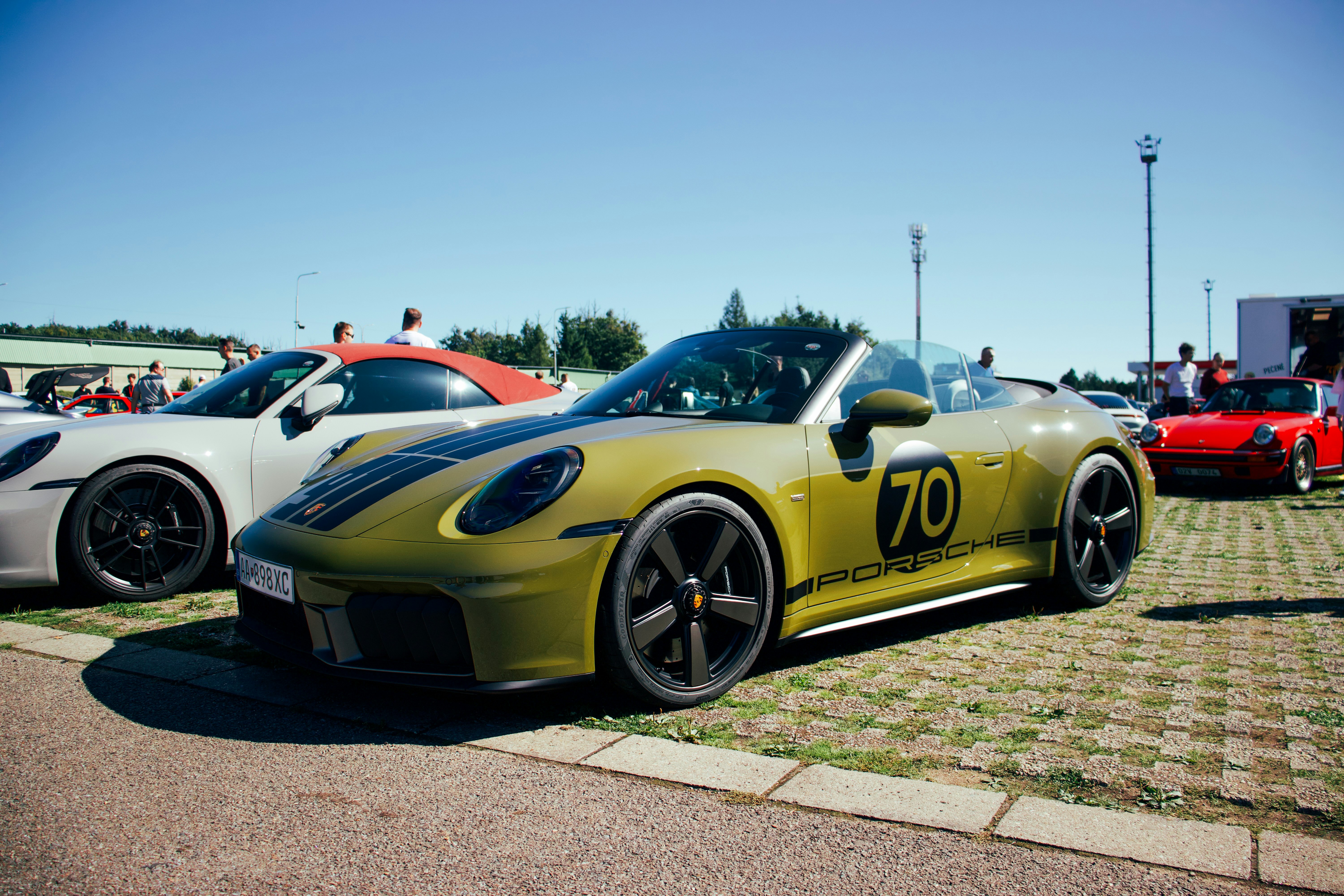Green Porsche 911 GT3 RS at carshow, bold number 70 and vivid yellow body