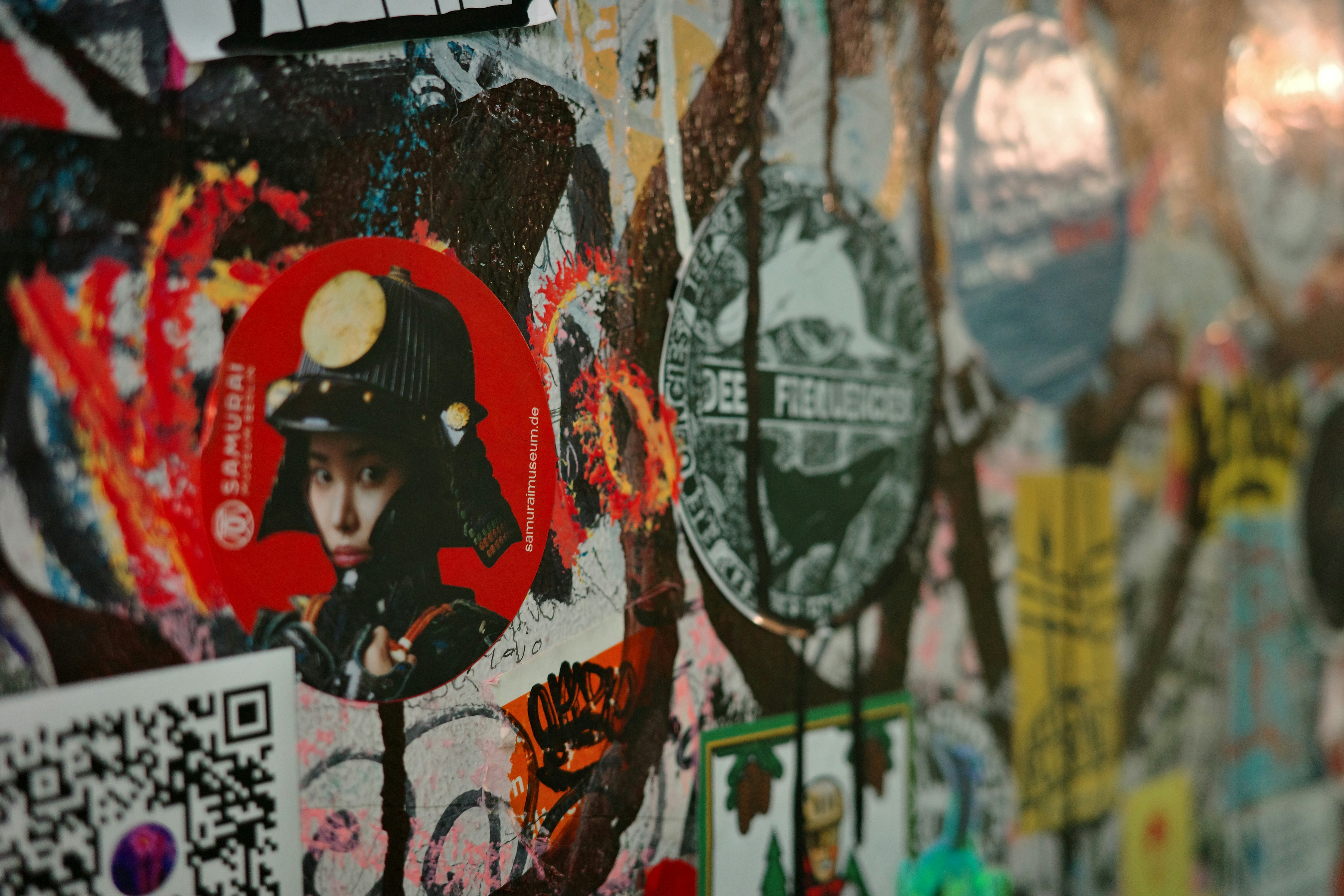 Red-eyed portrait in a collage of street stickers