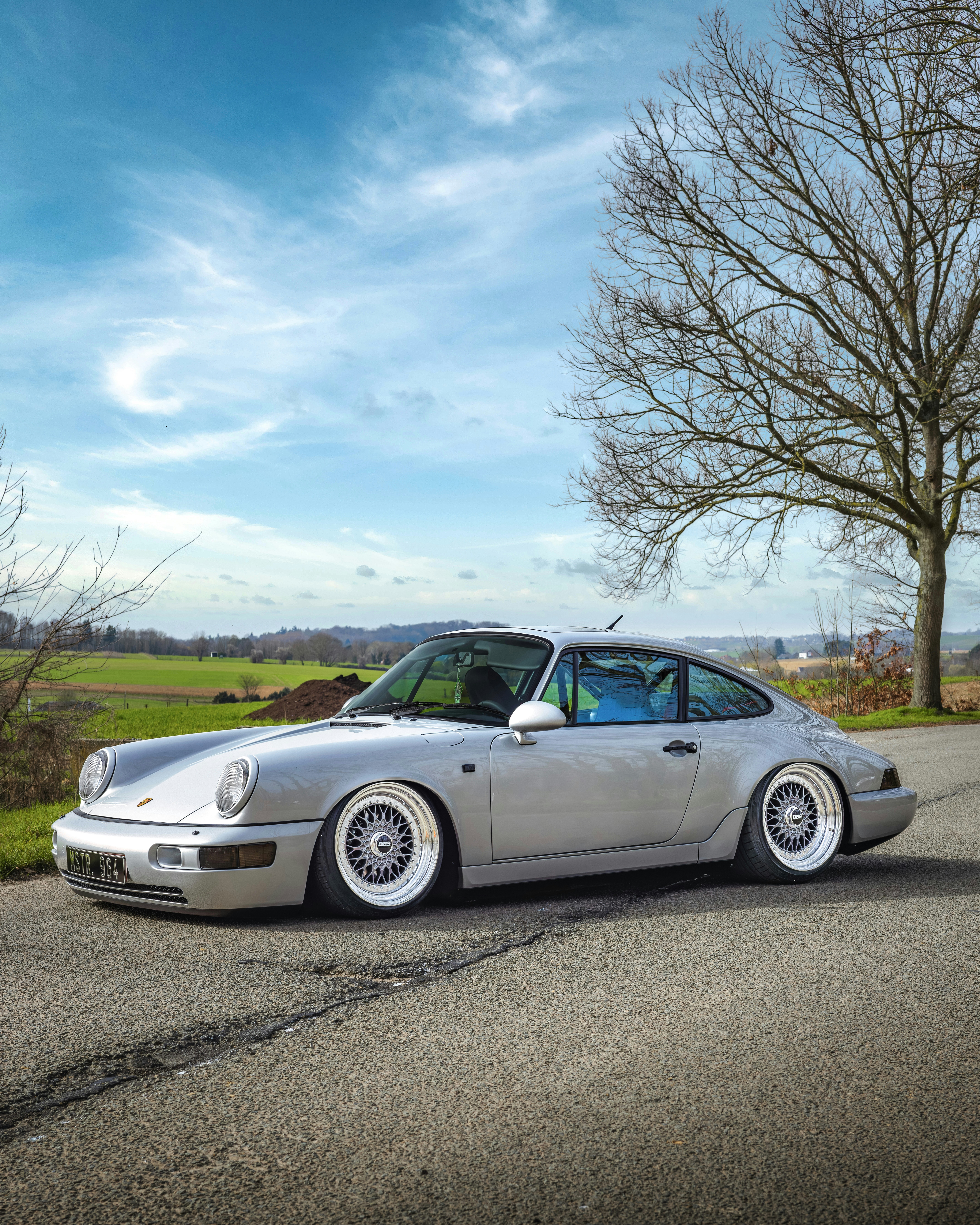 Silver Porsche on a Quiet Country Road at Twilight