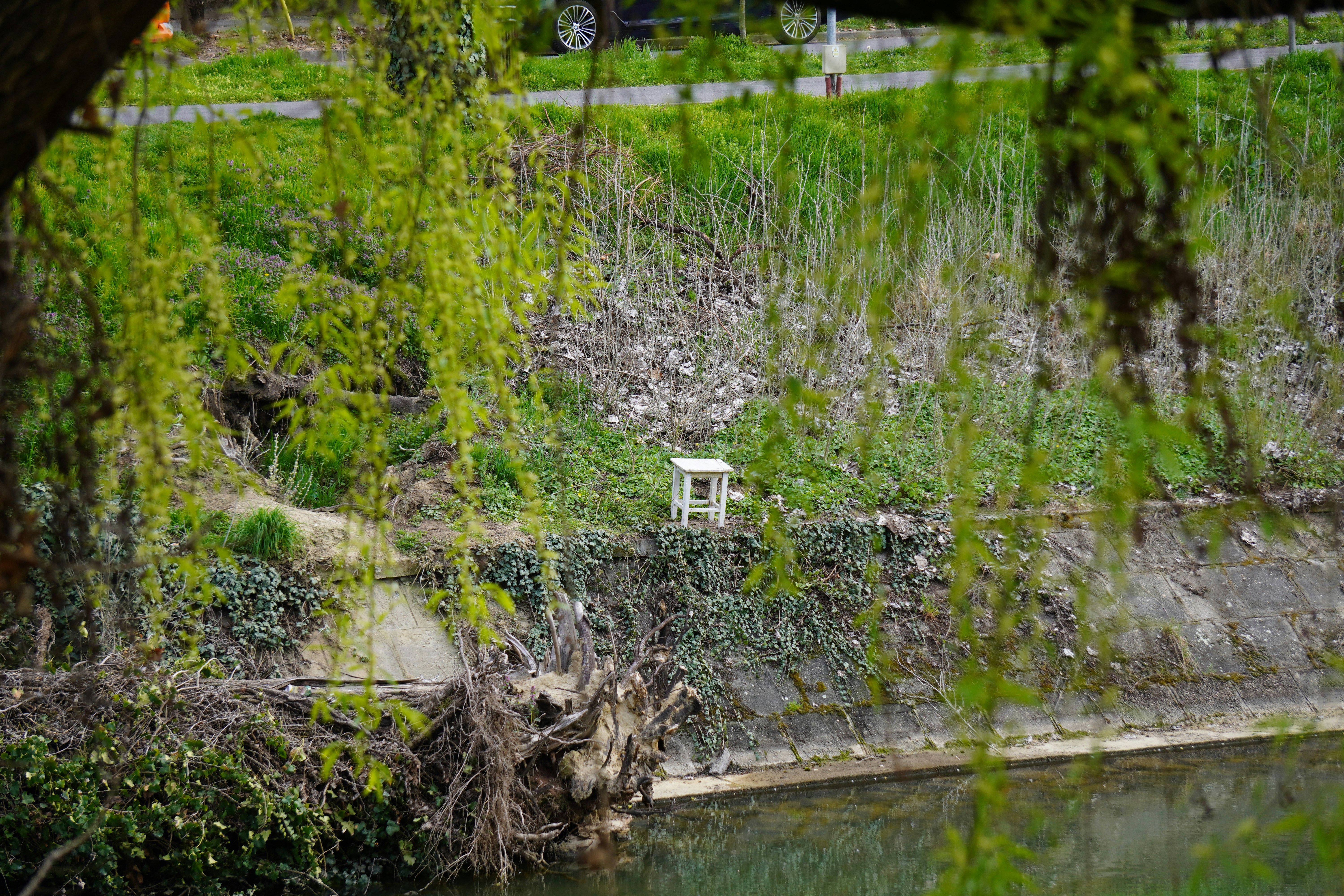 Tiny Stool, Large Riverbank: A Quiet Verge by the Water