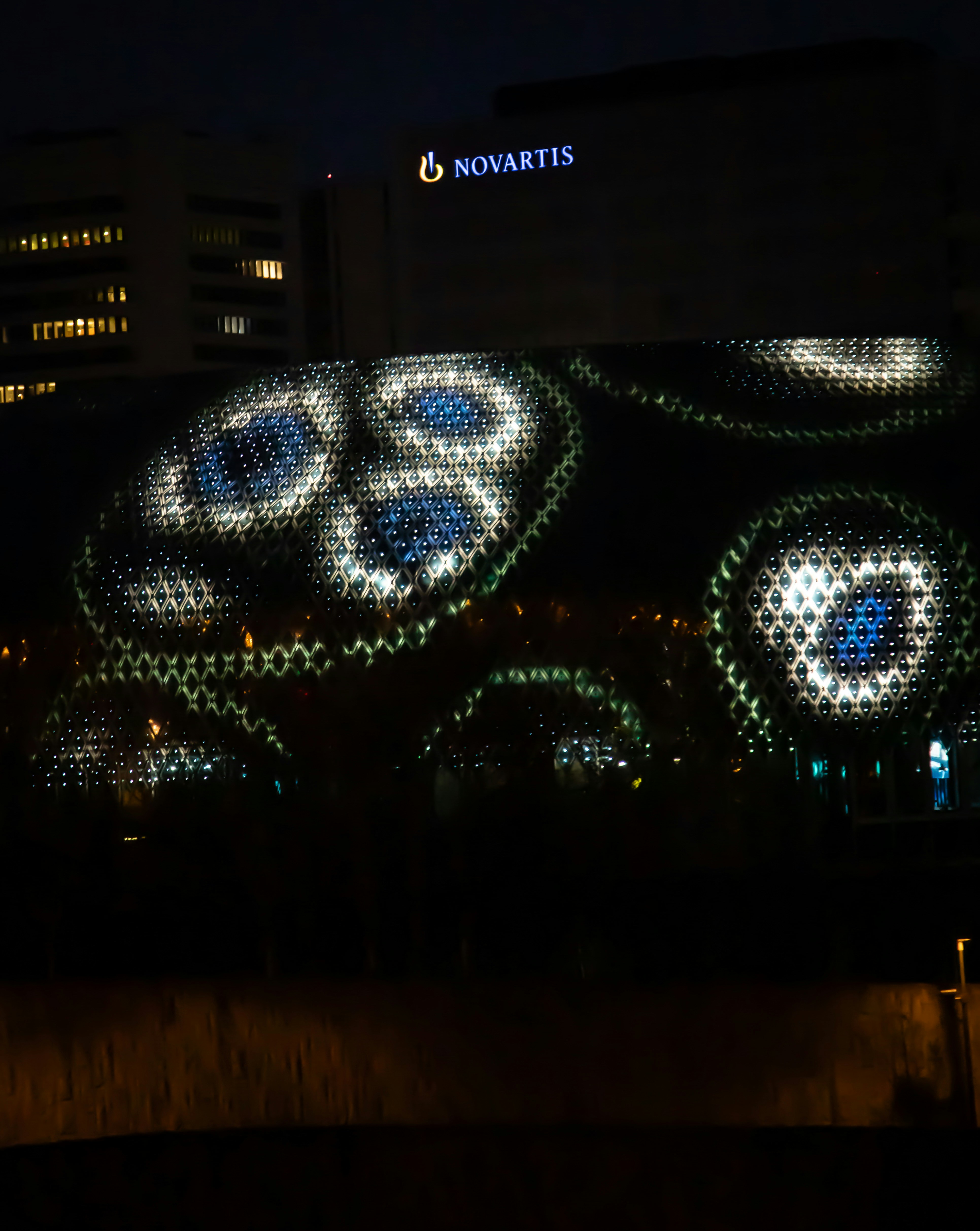 Glowing orbs on a midnight facade