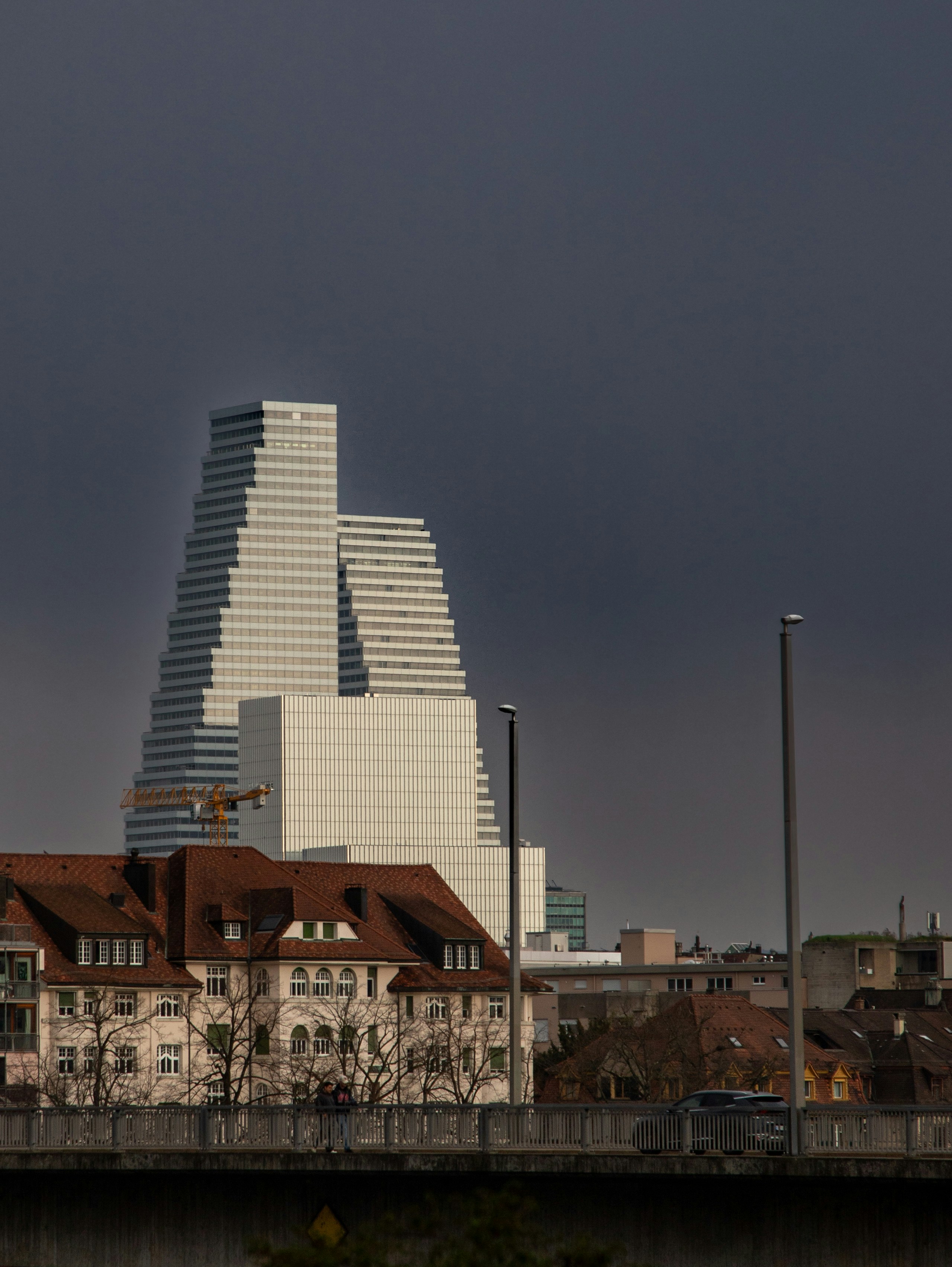 Towers of Light and Shadow over a Riverside Street