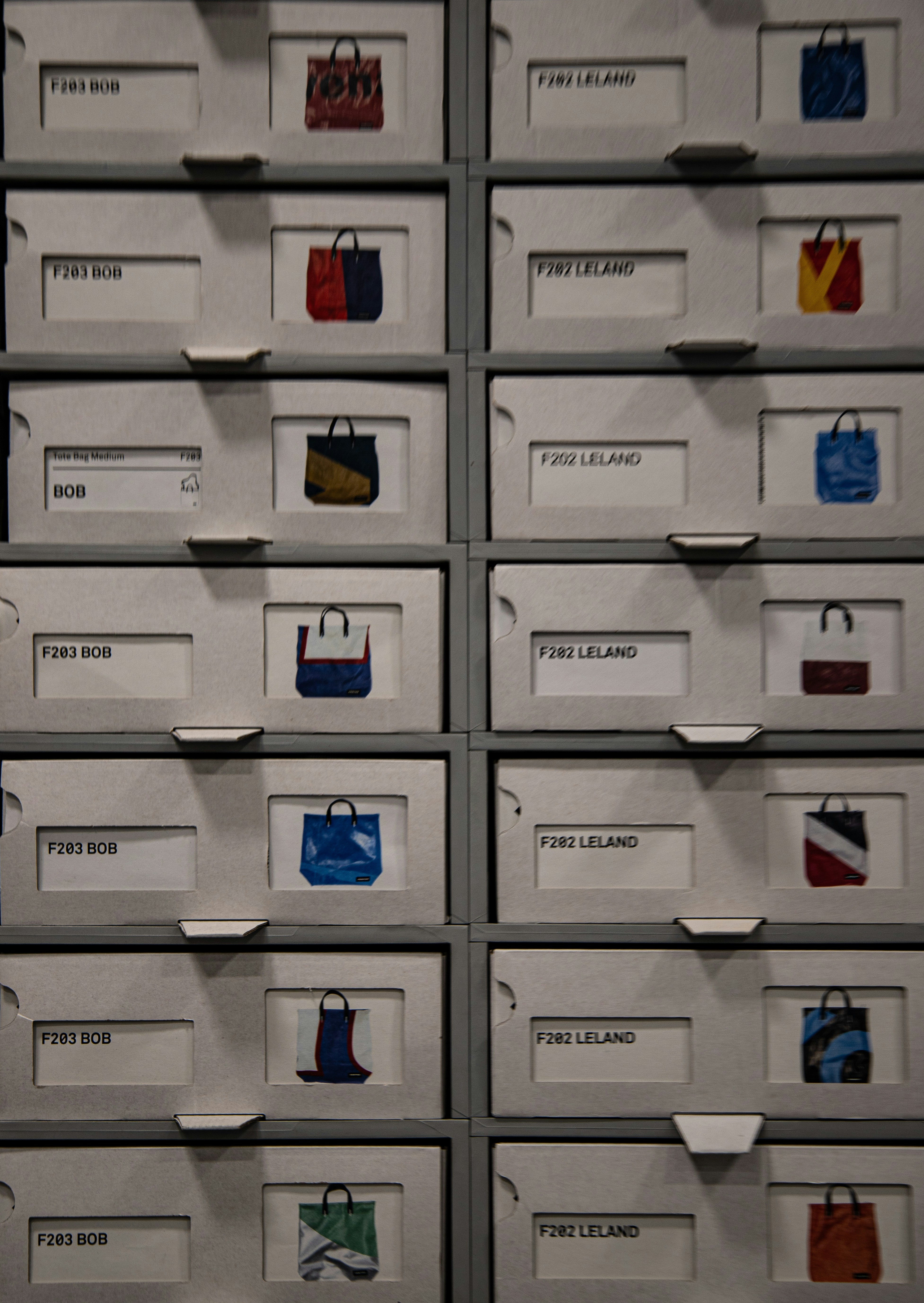 Organized Dispatch: A Grid of Labeled Drawers with Colorful Bags