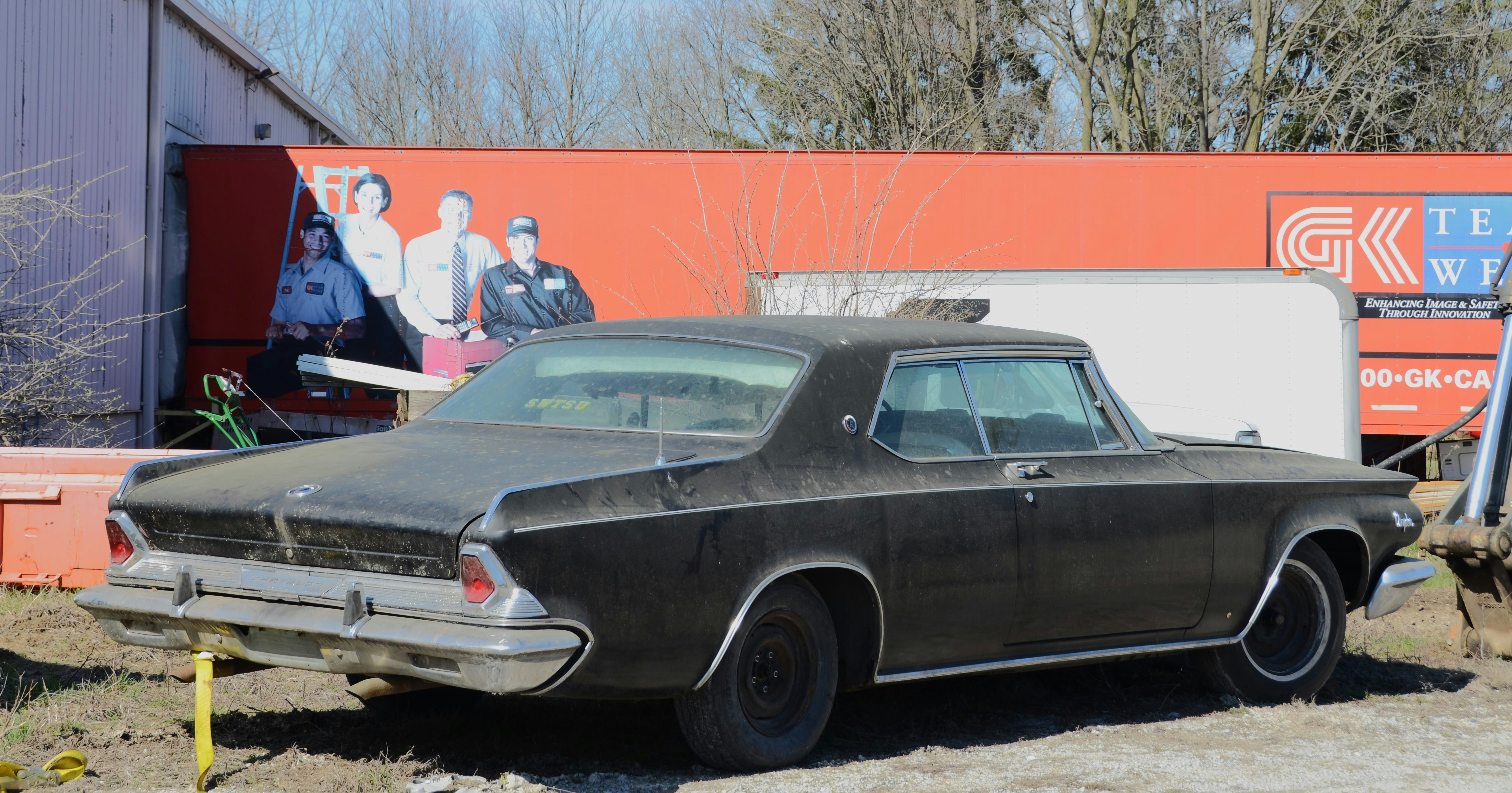 Dusty Classic: A late-60s Chevrolet in a sunlit junkyard