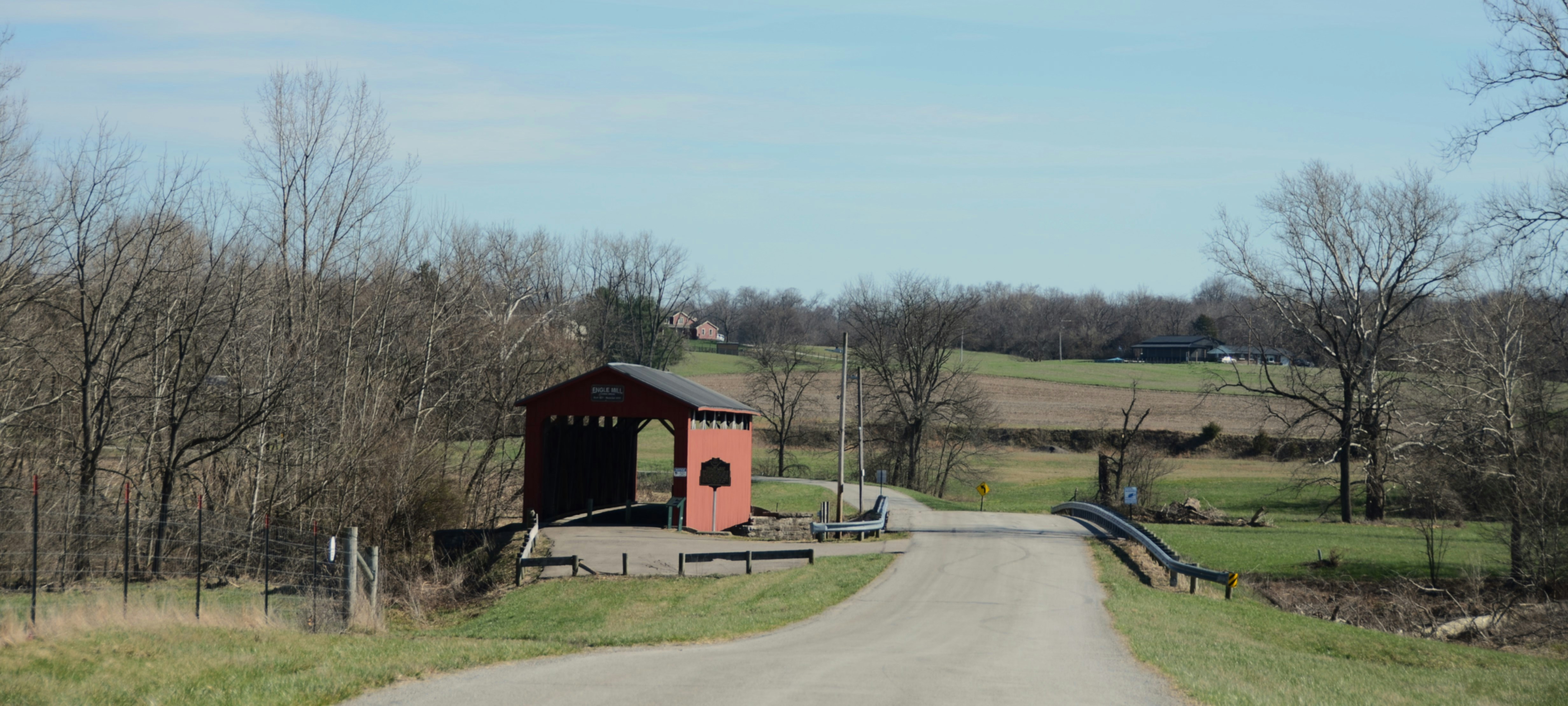 Red Covered Bridge Over a Quiet Farm Lane