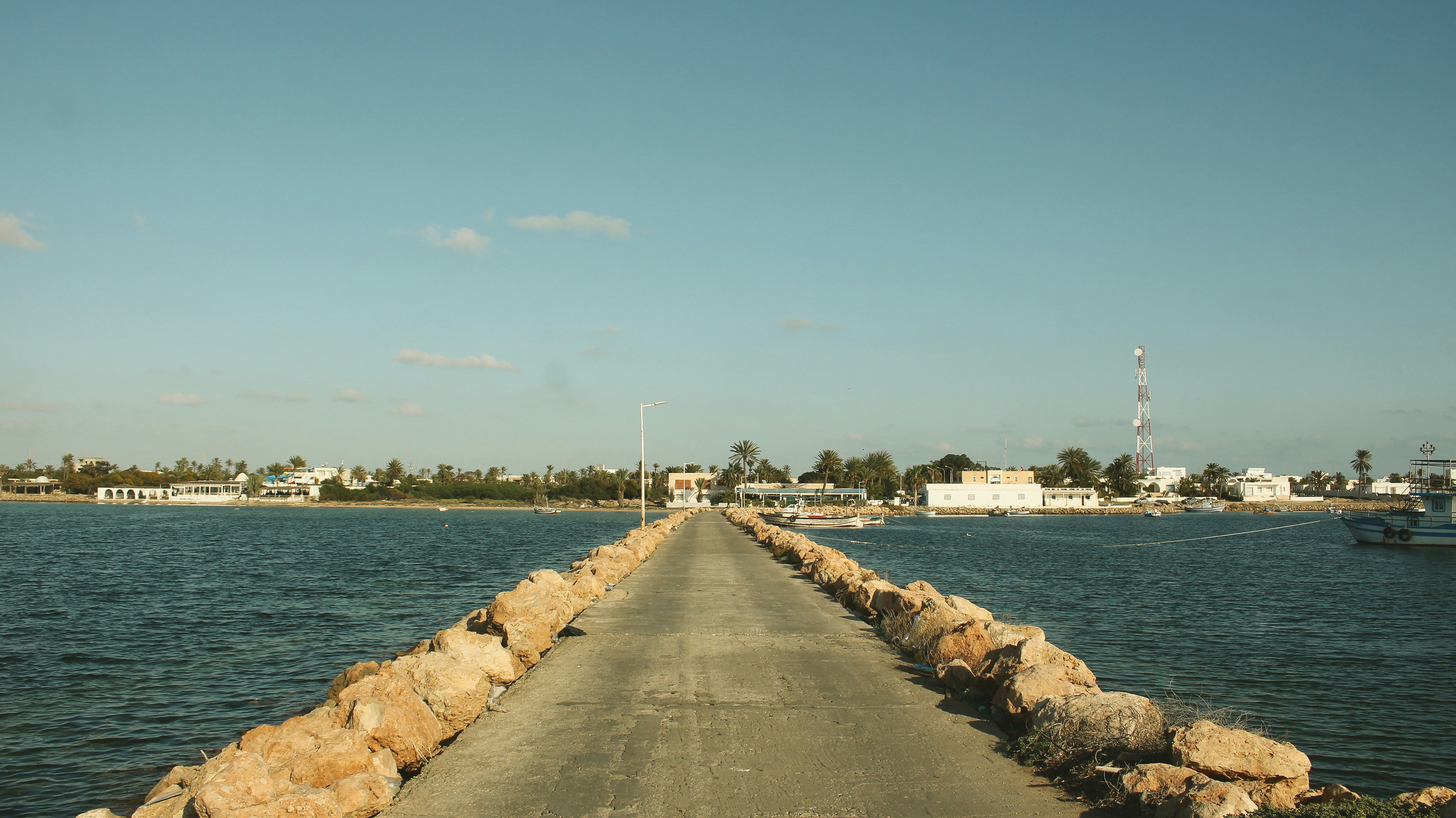 Rock-pier to the horizon: a calm passage over turquoise waters