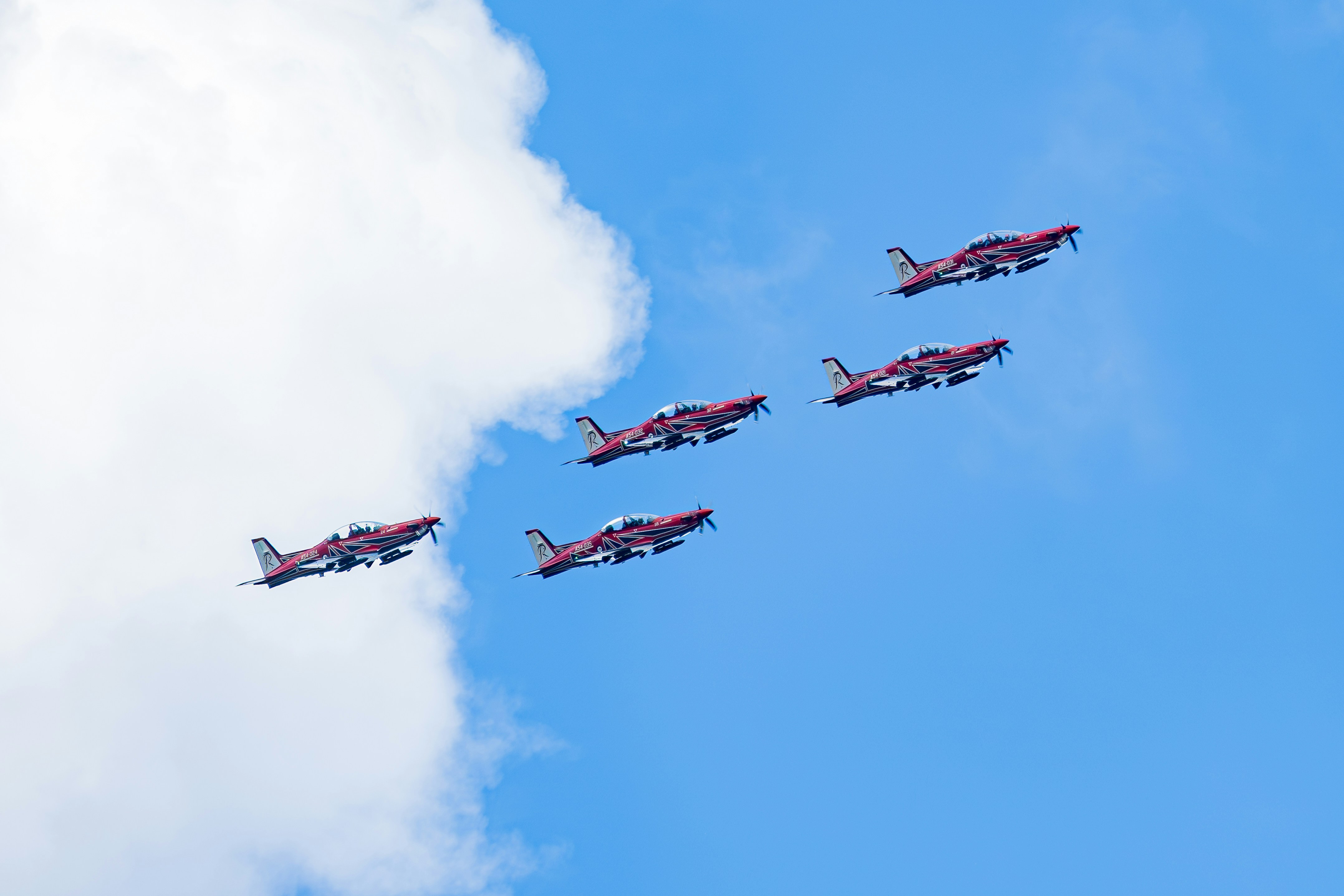 V-formation in the Sky: Four Trainers Arc Across a Clear Blue