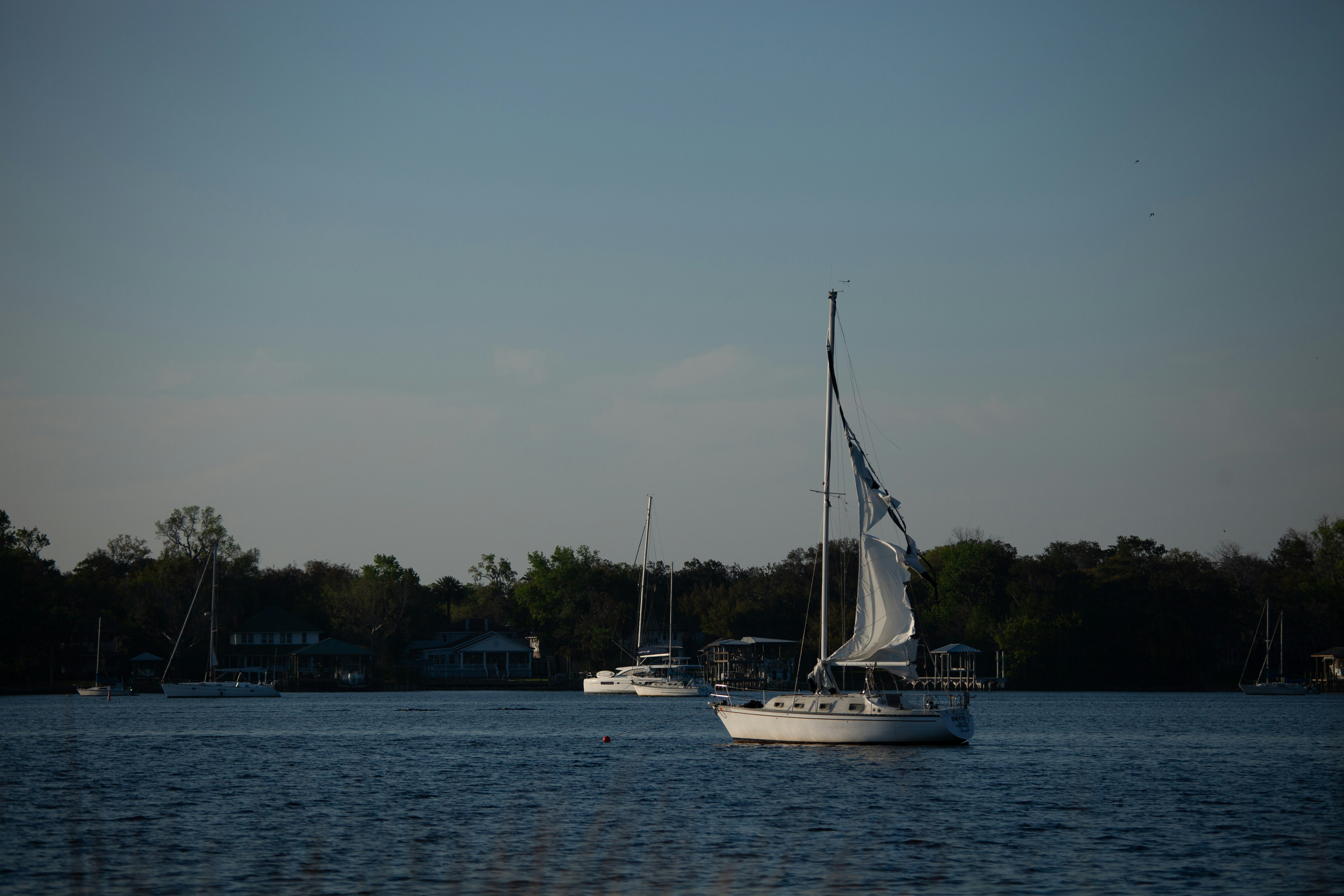 Sailboat on a Glassy Bay at Dusk