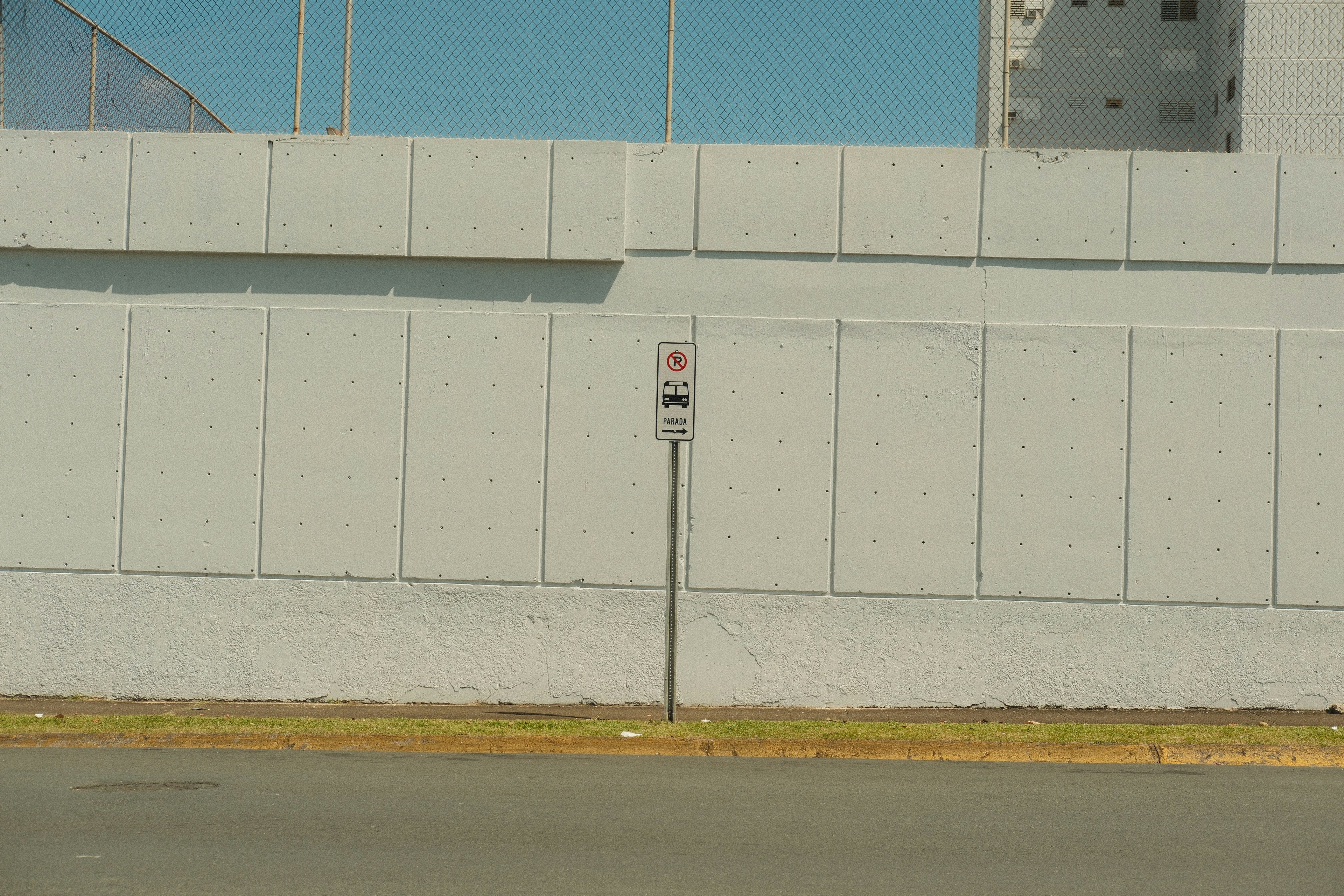 Midway Boundary: A Quiet Street Sign Between Concrete Expanse