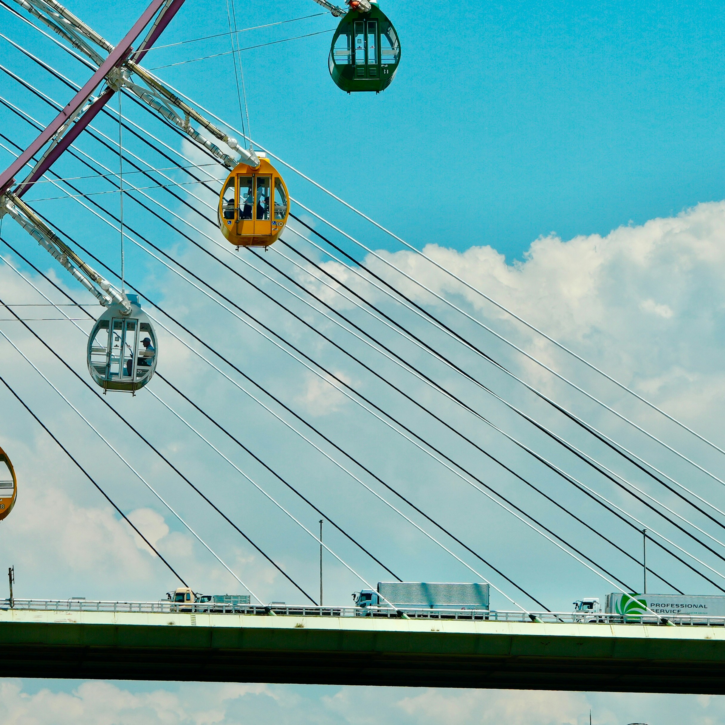 Skyline Carousel: Aerial Cables and Colorful Gondolas Over a Blue Sky